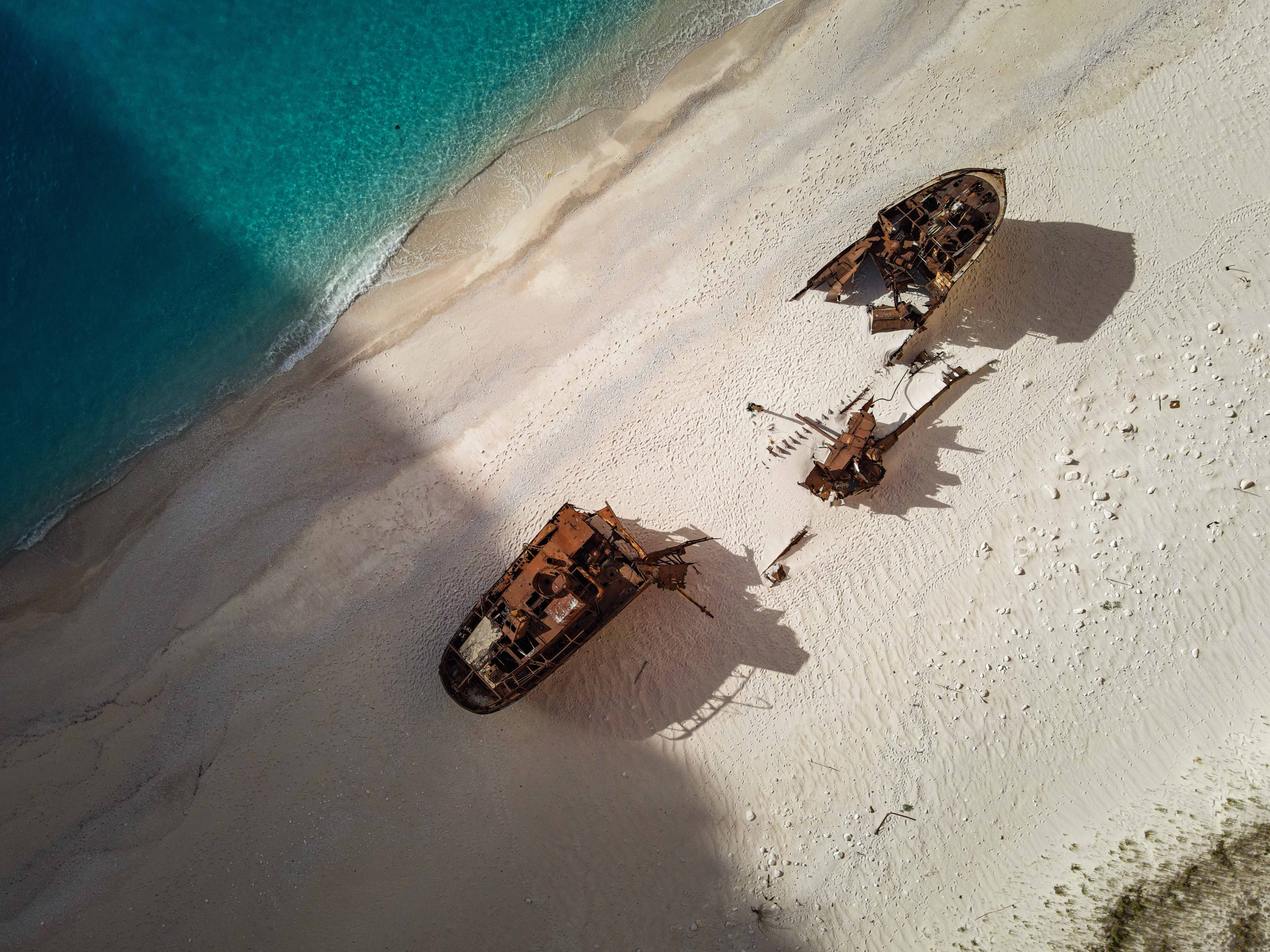 An aerial view of a beach with two boats · Free Stock Photo