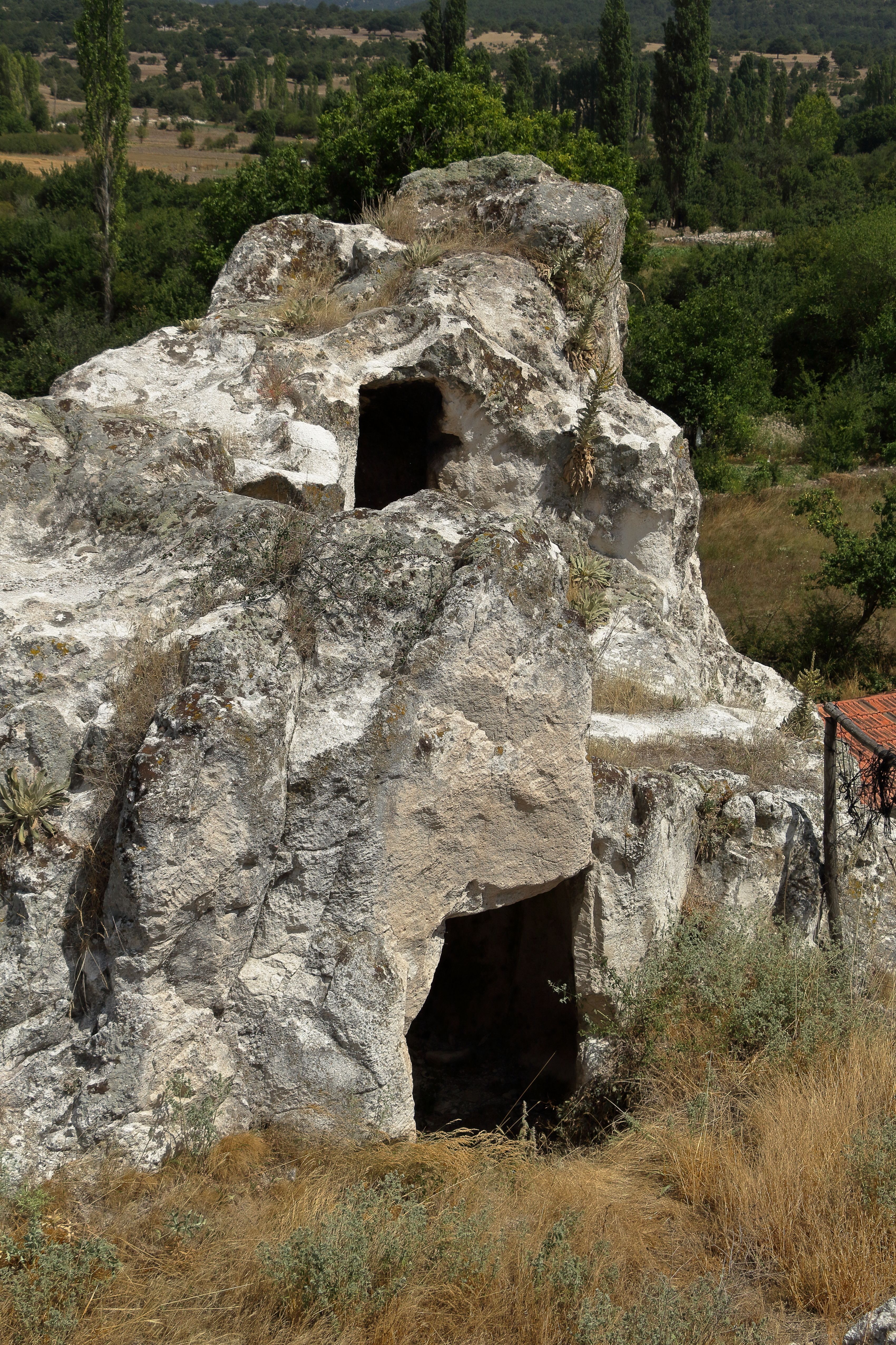 A small stone building with two doors on it · Free Stock Photo