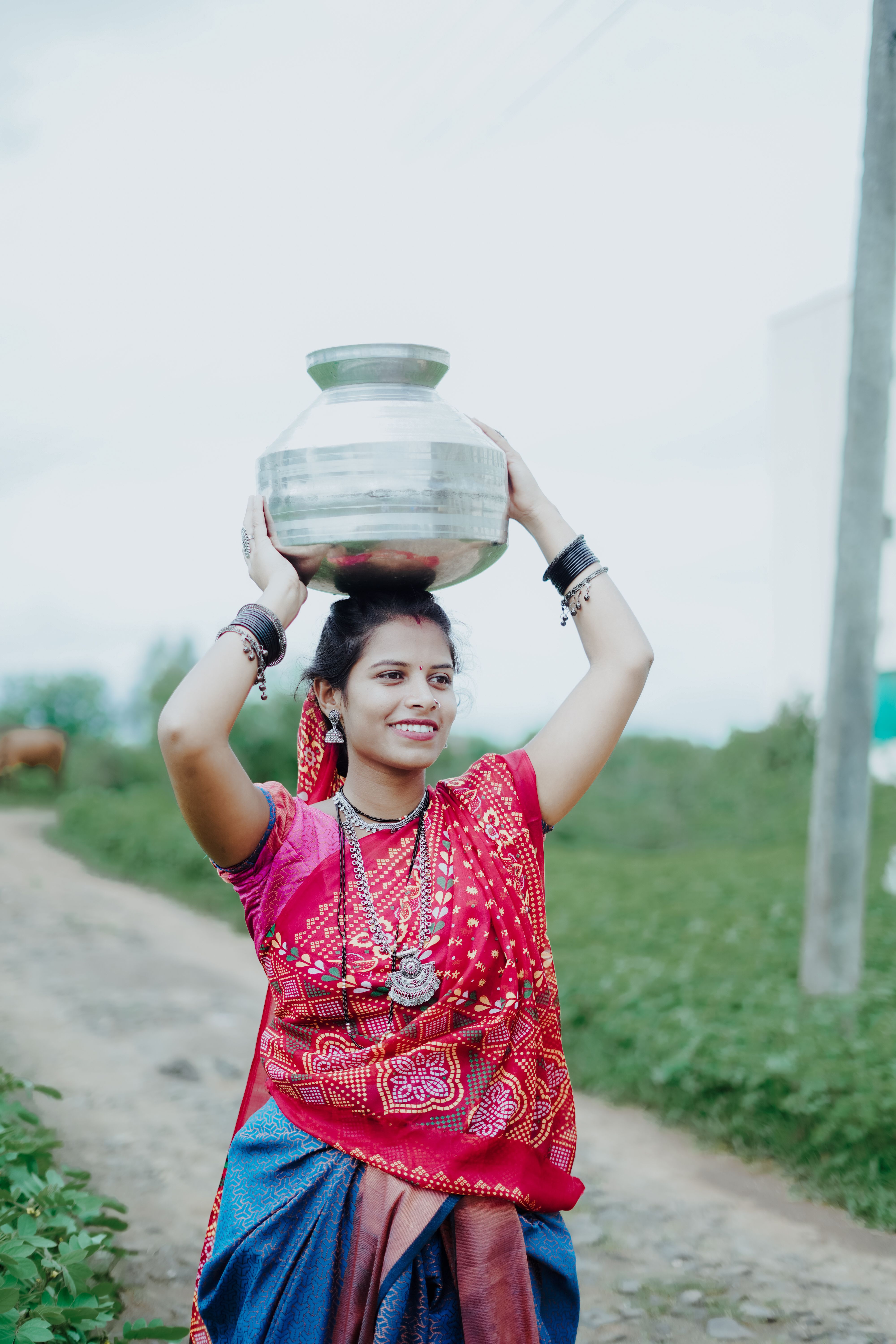 A woman carrying a large pot on her head · Free Stock Photo