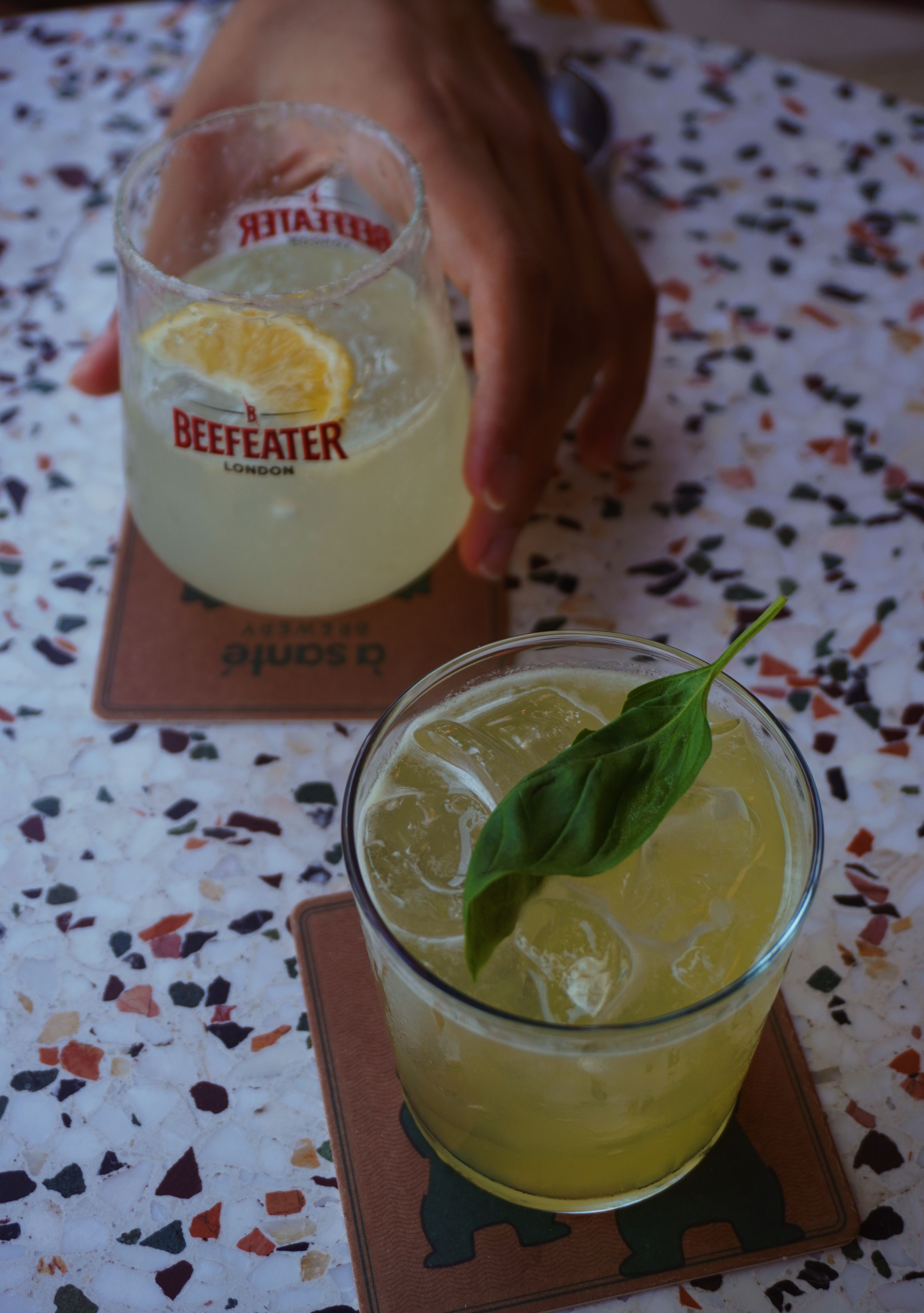 Two drinks on a table with a lemon wedge · Free Stock Photo