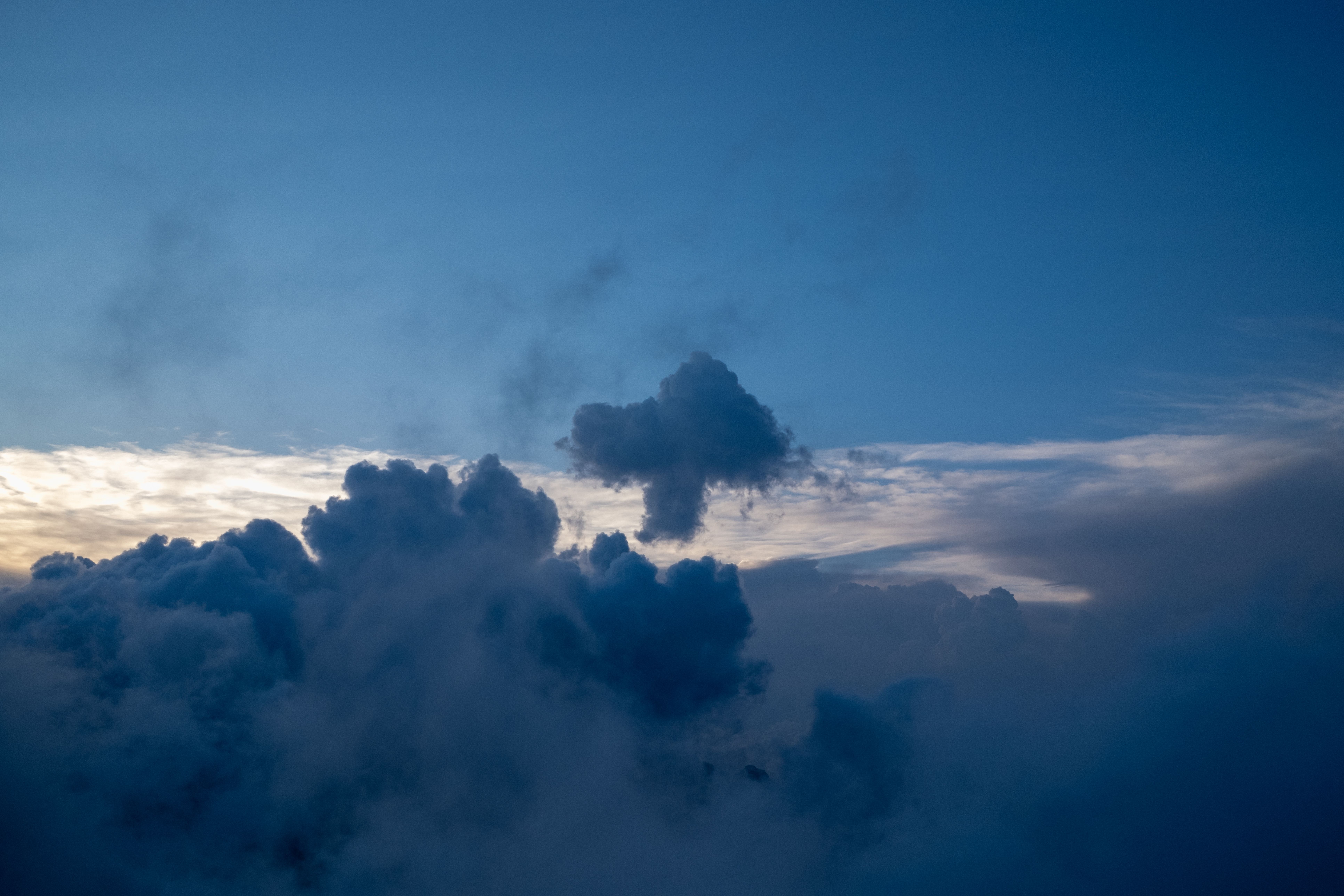 A blue sky with clouds in the distance · Free Stock Photo