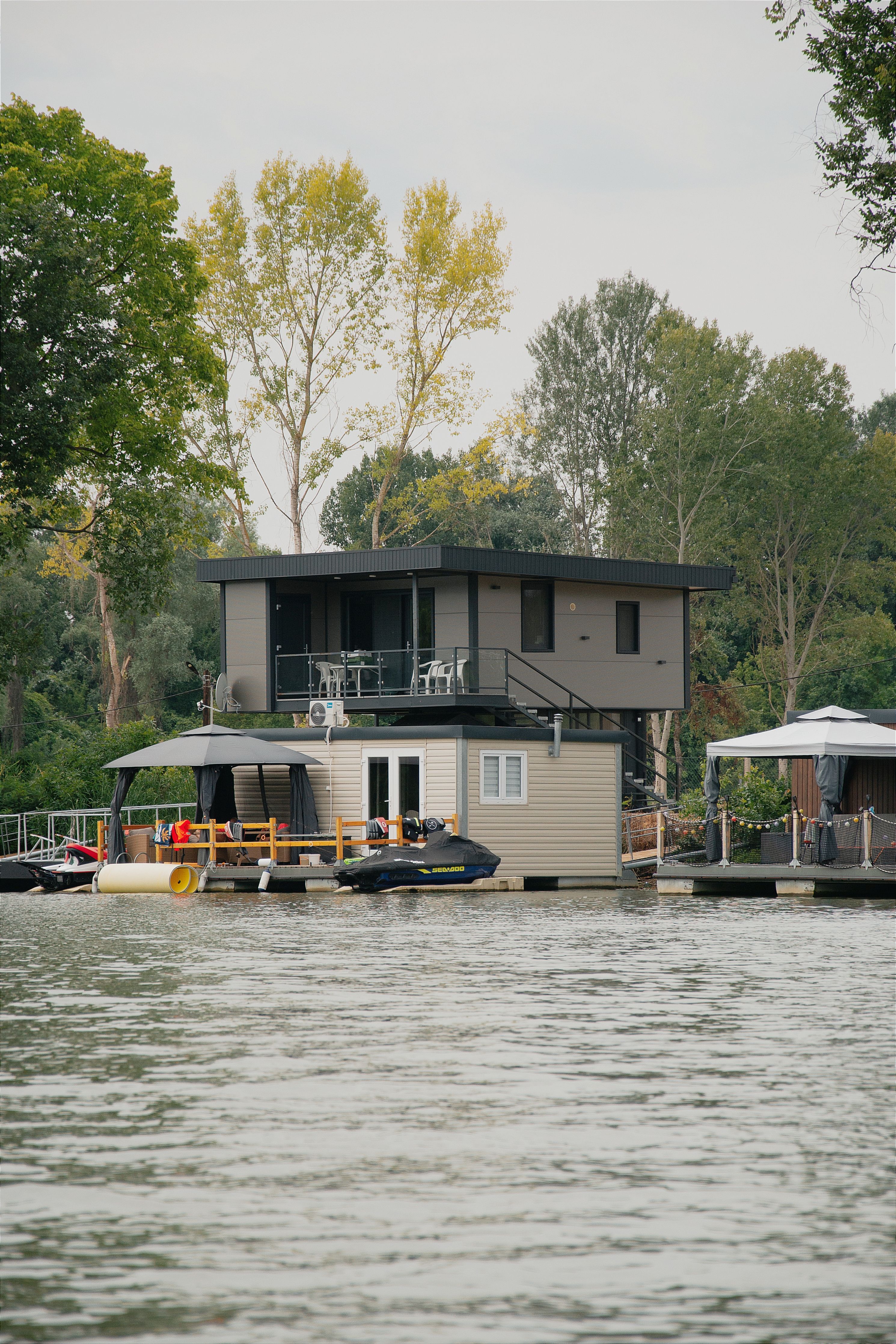 A houseboat on the water with a dock · Free Stock Photo