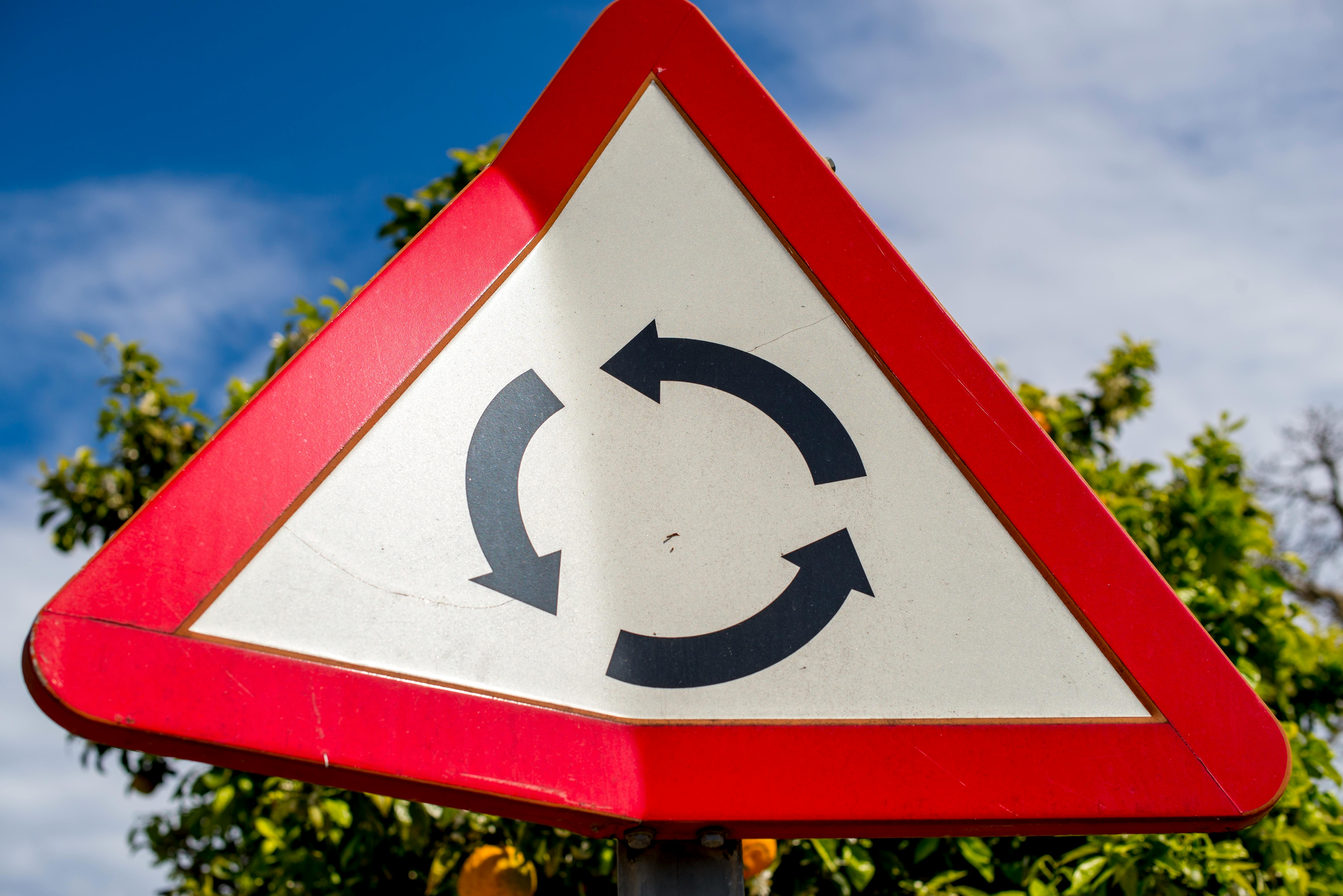 Close-up of a Roundabout Warning Sign · Free Stock Photo