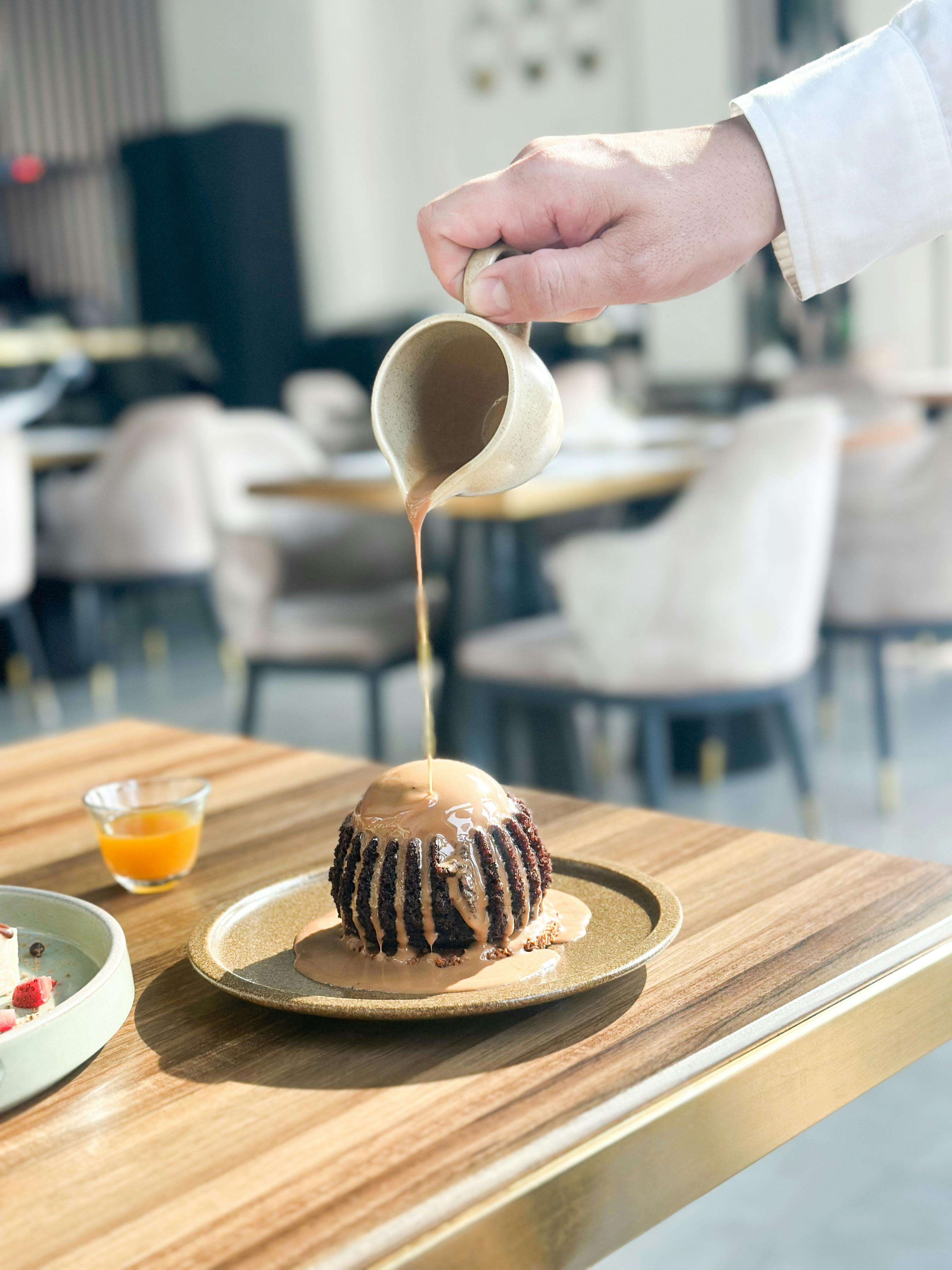 Decadent Dessert with Chocolate Sauce in Modern Cafe · Free Stock Photo