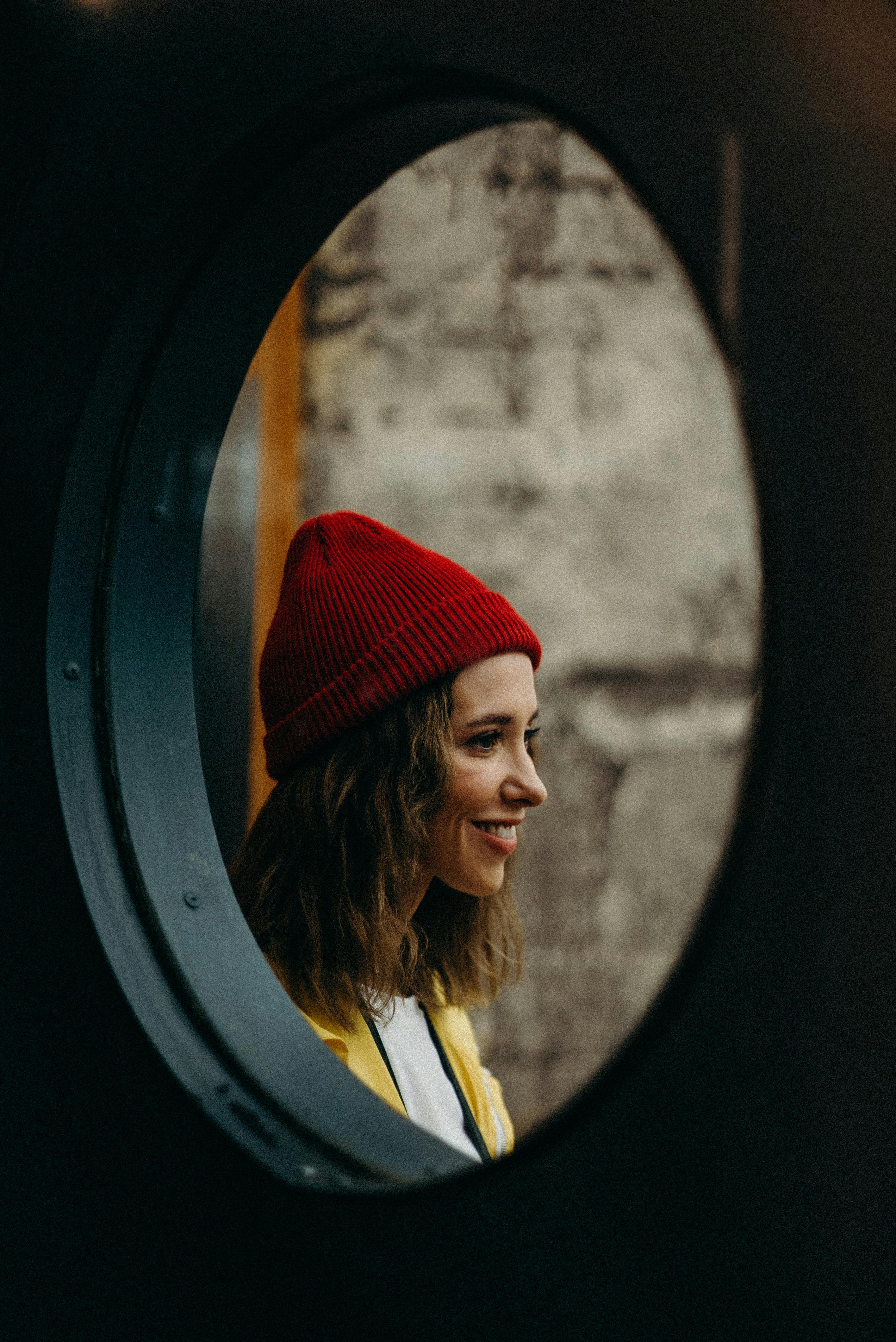 Smiling Woman Wearing Red Knit Cap · Free Stock Photo