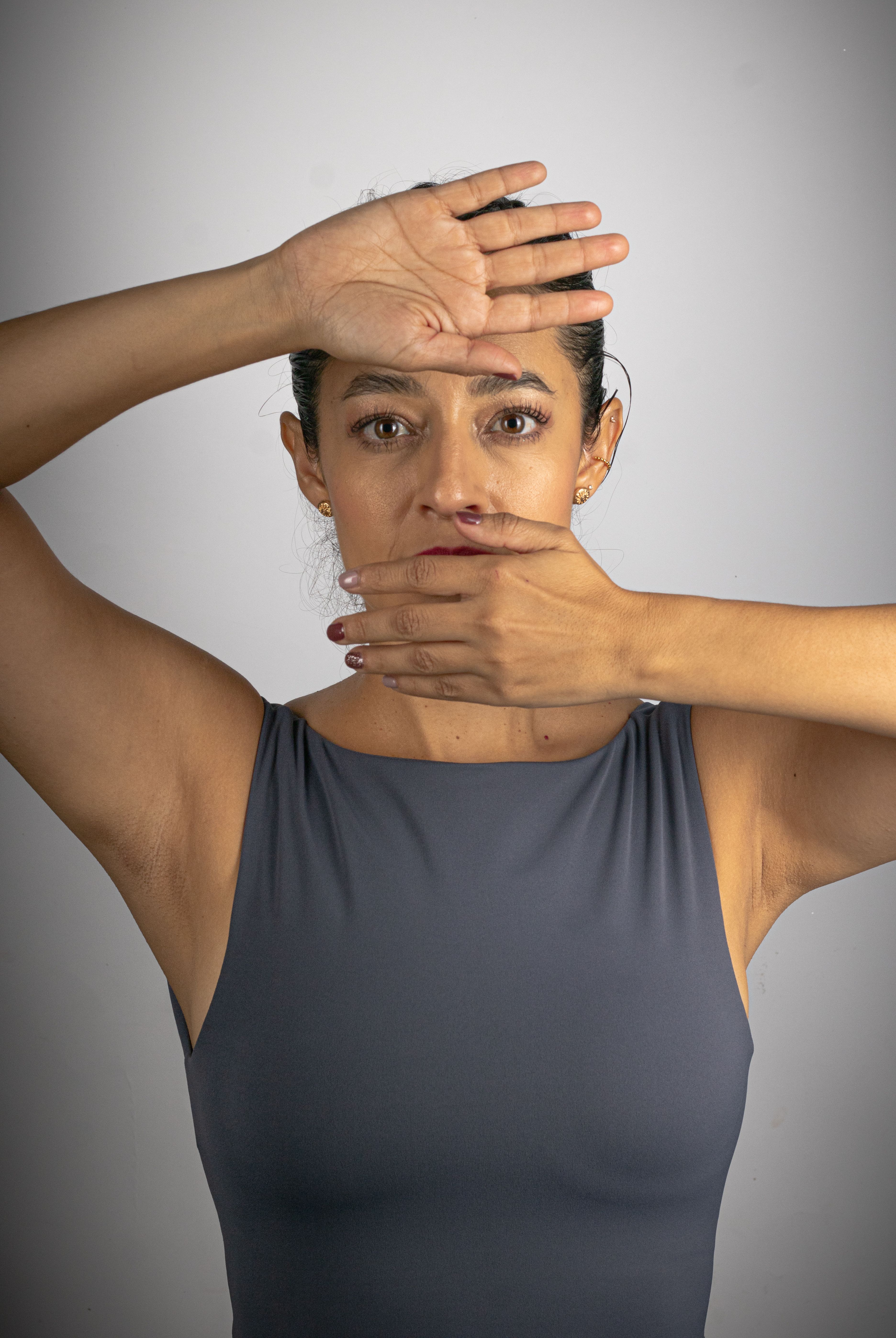 A woman covering her face with her hands · Free Stock Photo