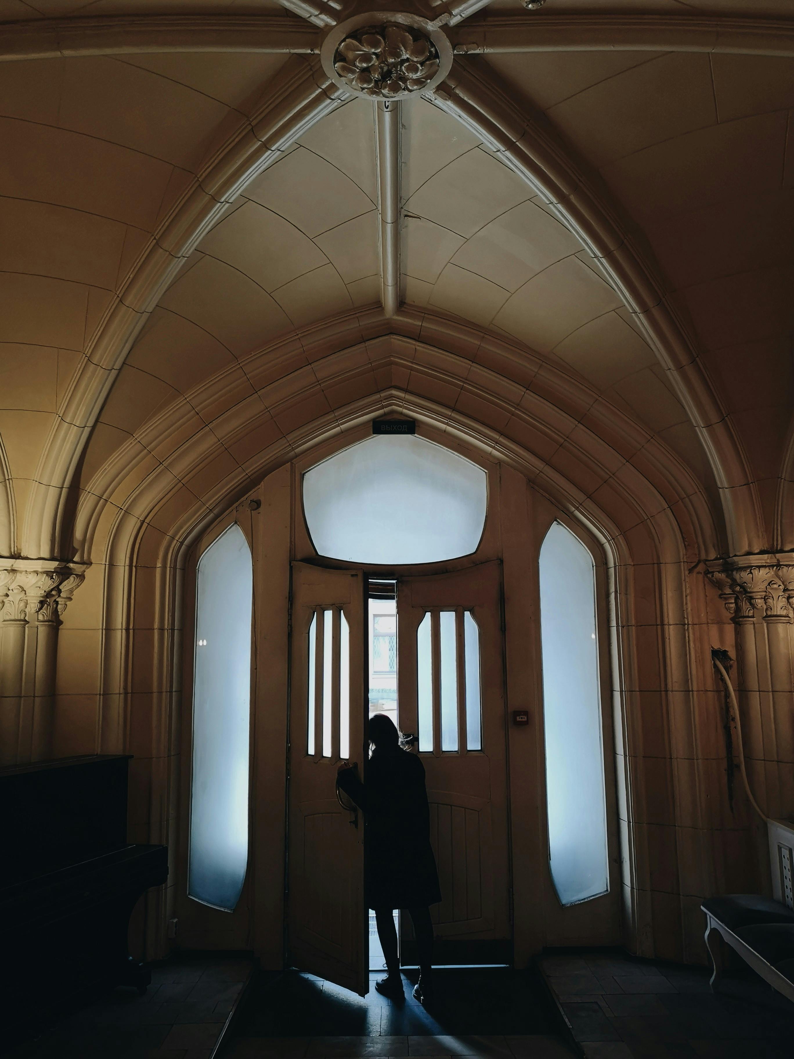 Woman Standing by an Open Door · Free Stock Photo