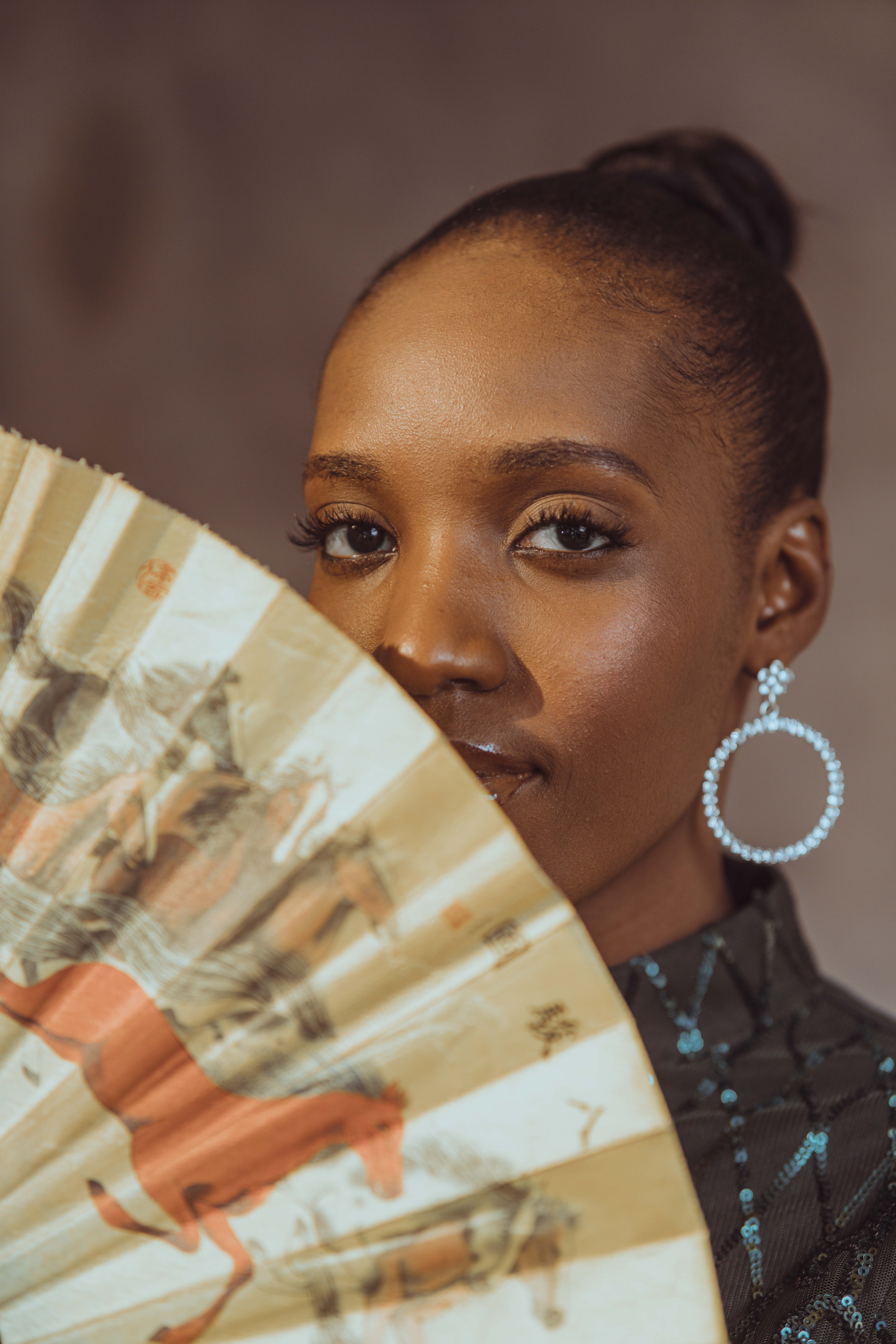A woman with a fan in her hand · Free Stock Photo