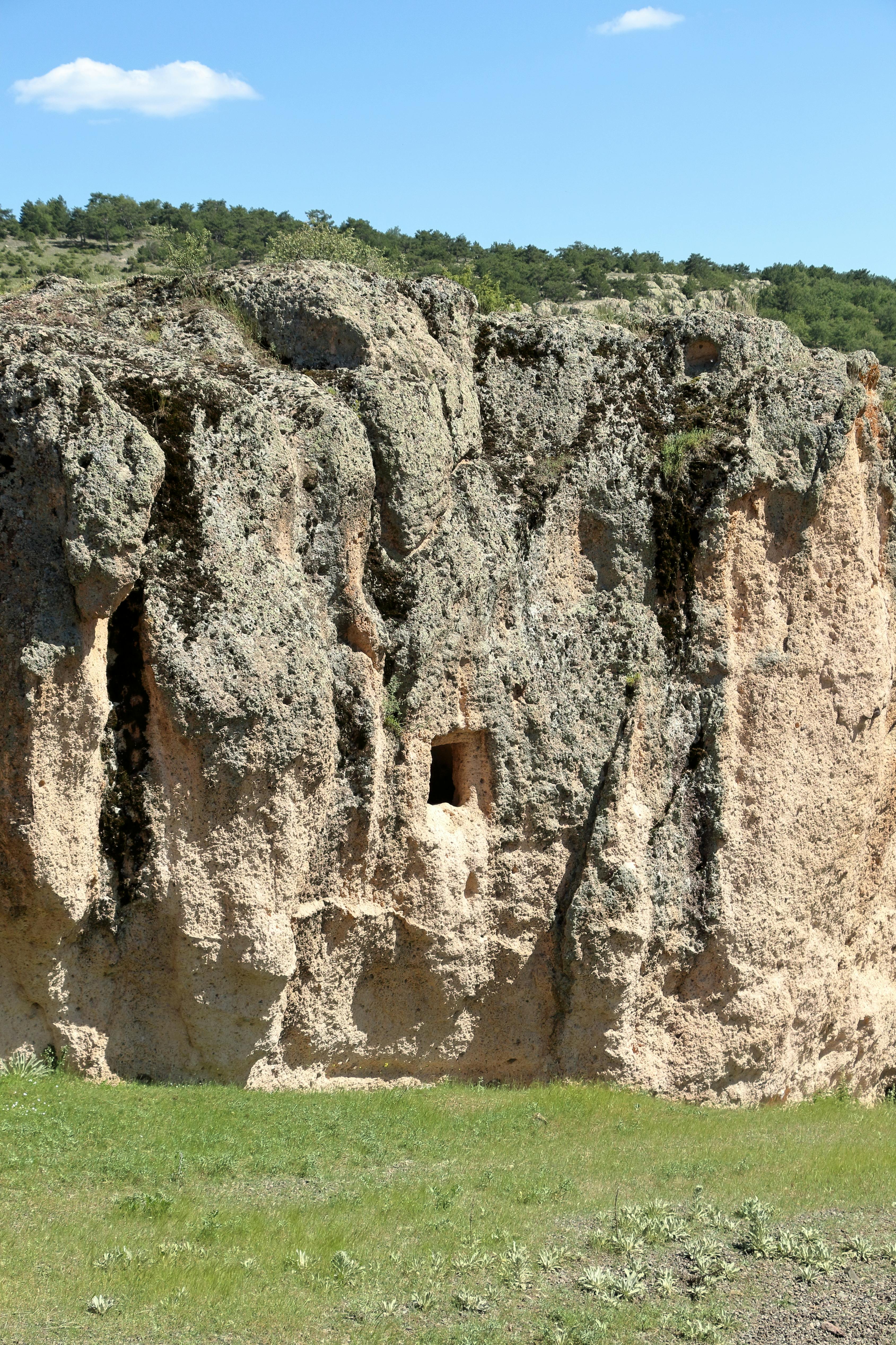 A cave in the side of a cliff · Free Stock Photo
