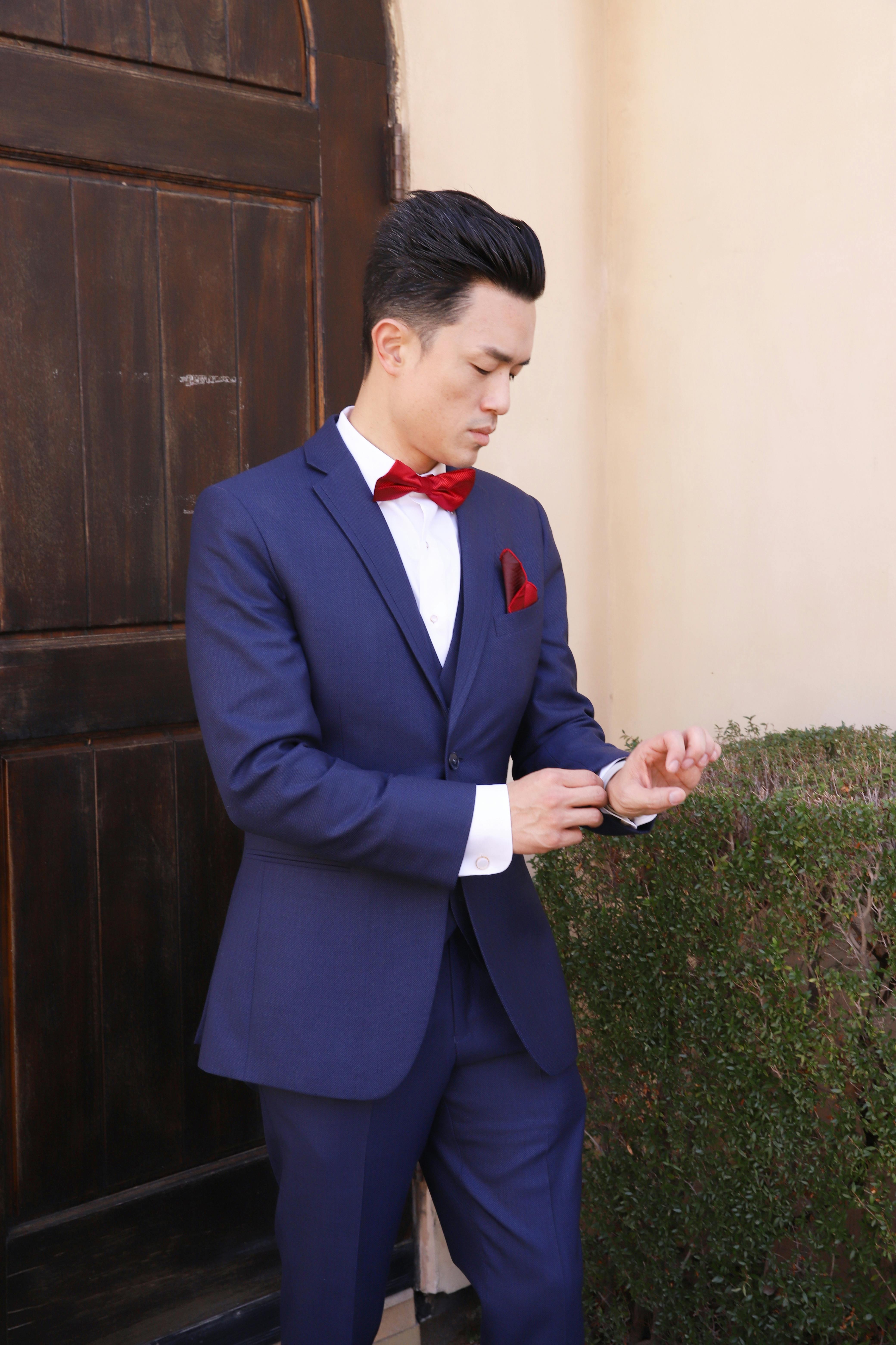 A man in a blue suit and red bow tie · Free Stock Photo