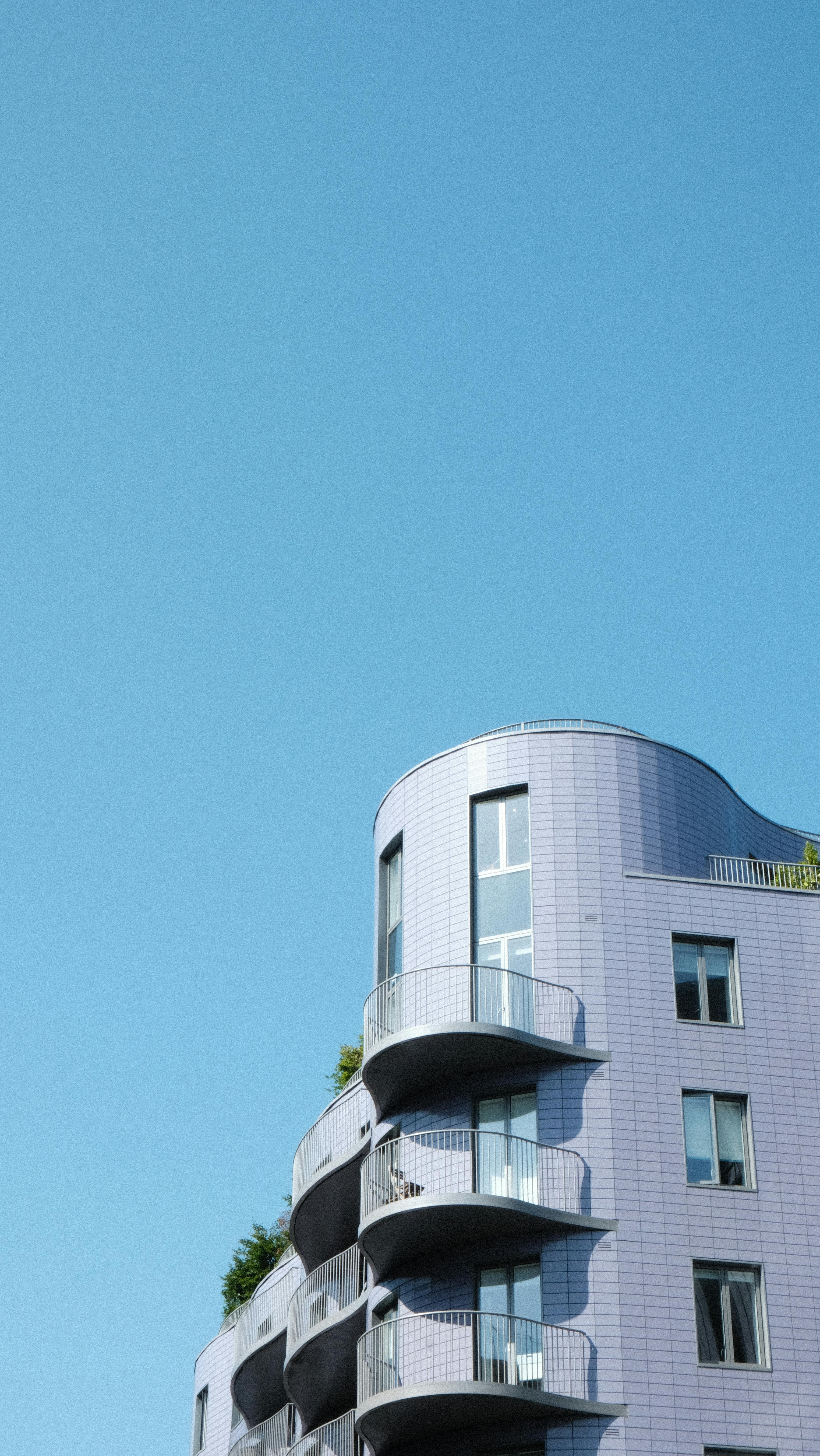 White and Gray Concrete Buildings With Green Trees Under Green Sky ...