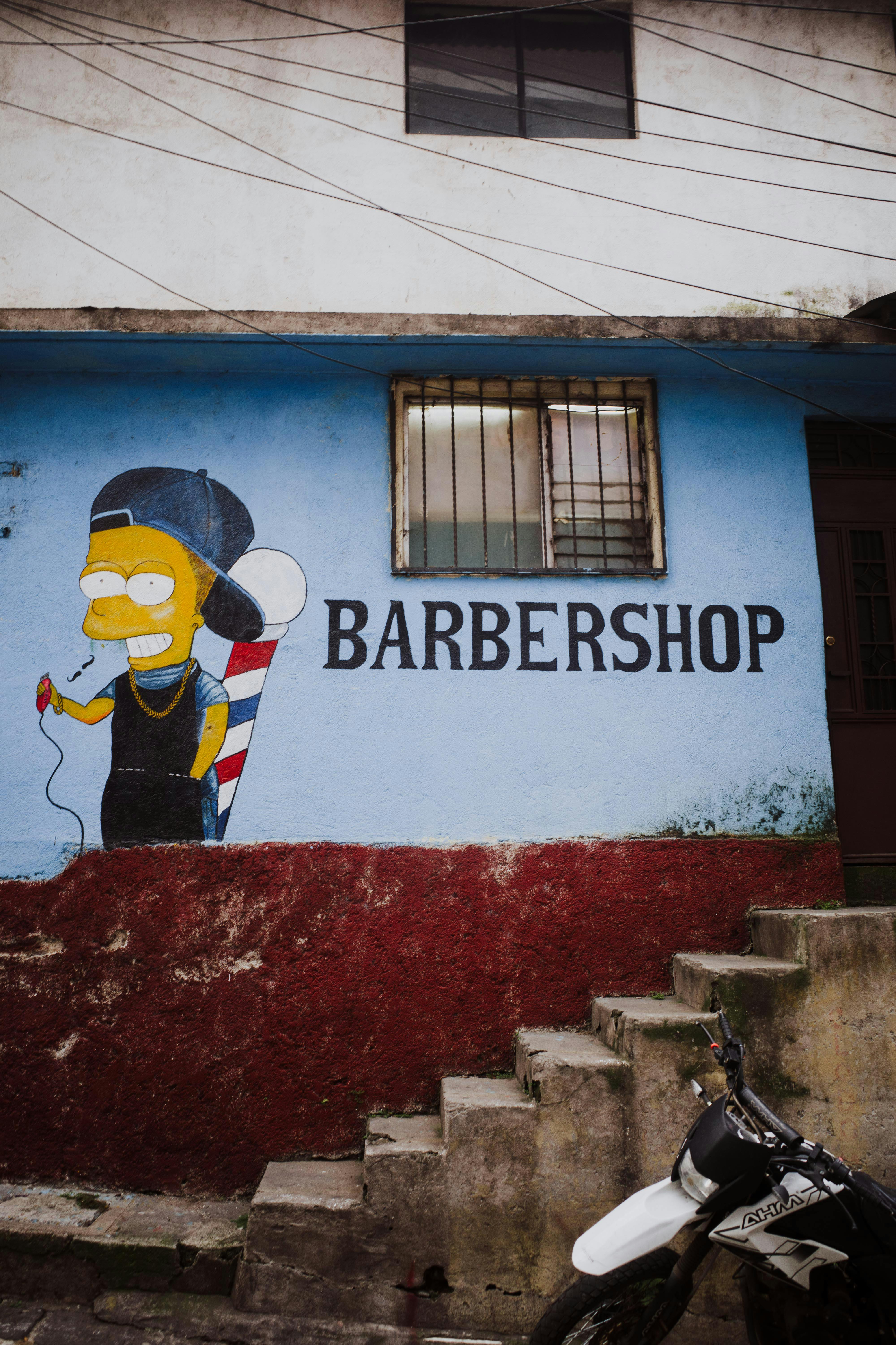 A mural of the simpsons character bart on the side of a building · Free ...