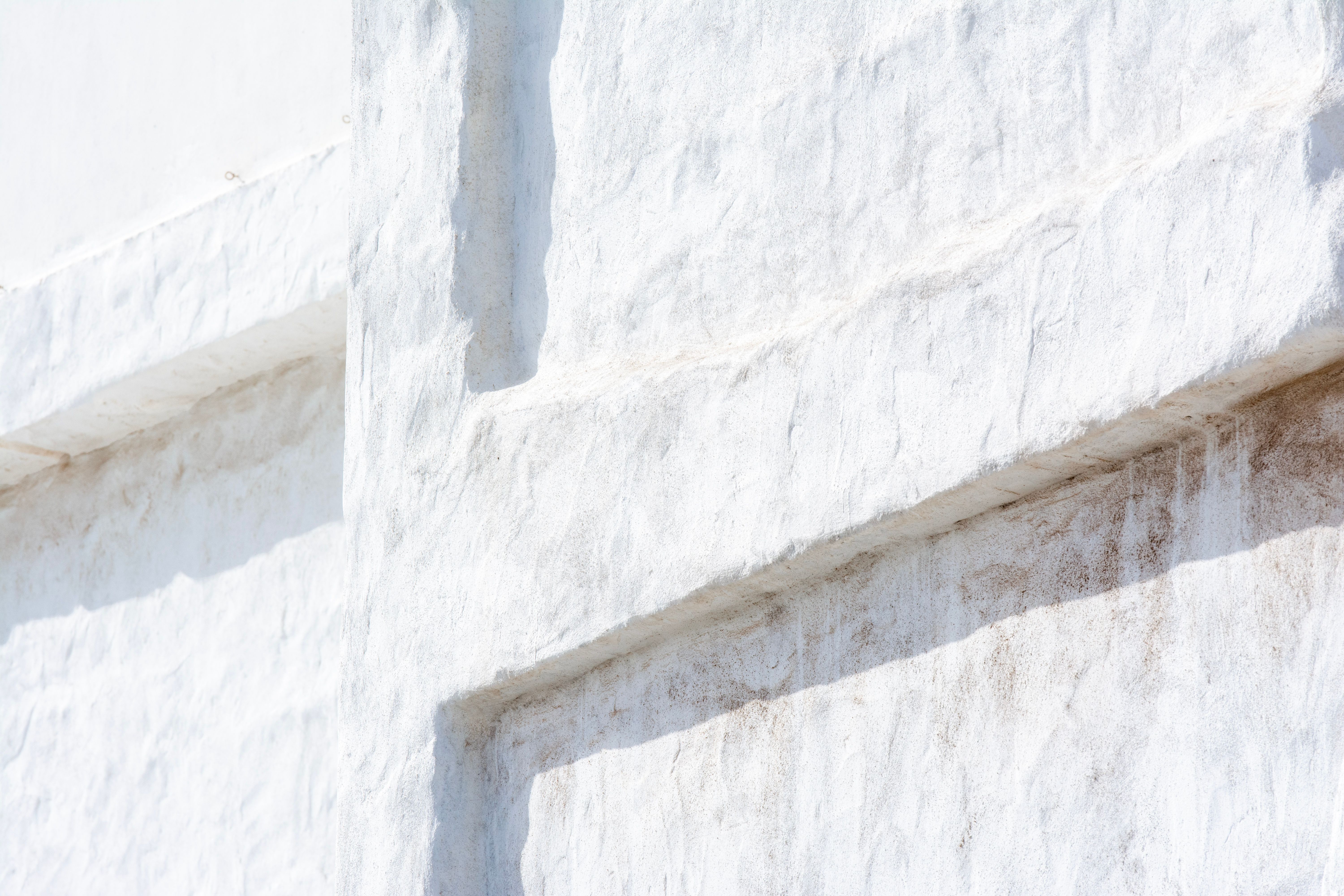 A close up of a white wall with a square pattern · Free Stock Photo