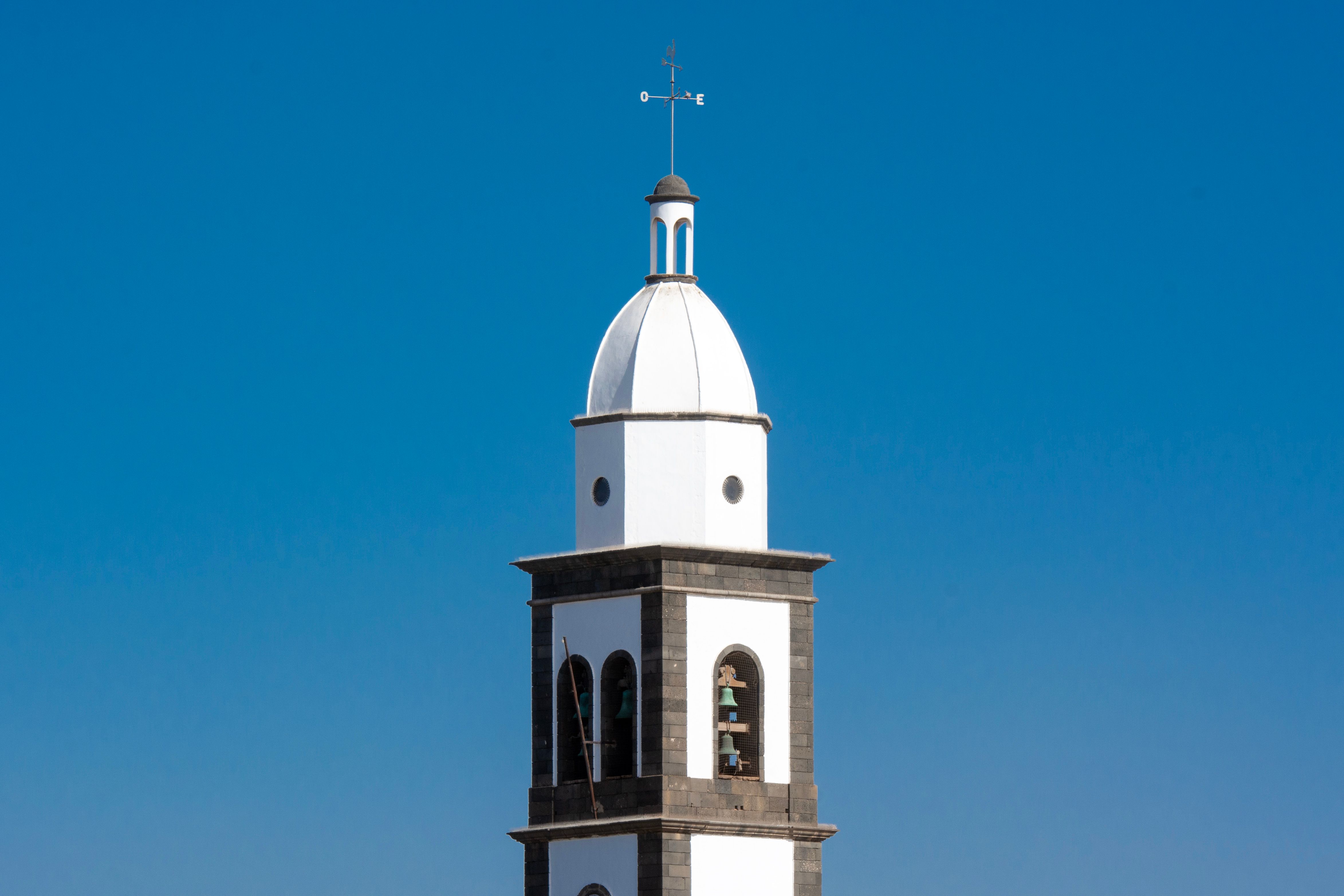 A church tower with a clock on top · Free Stock Photo