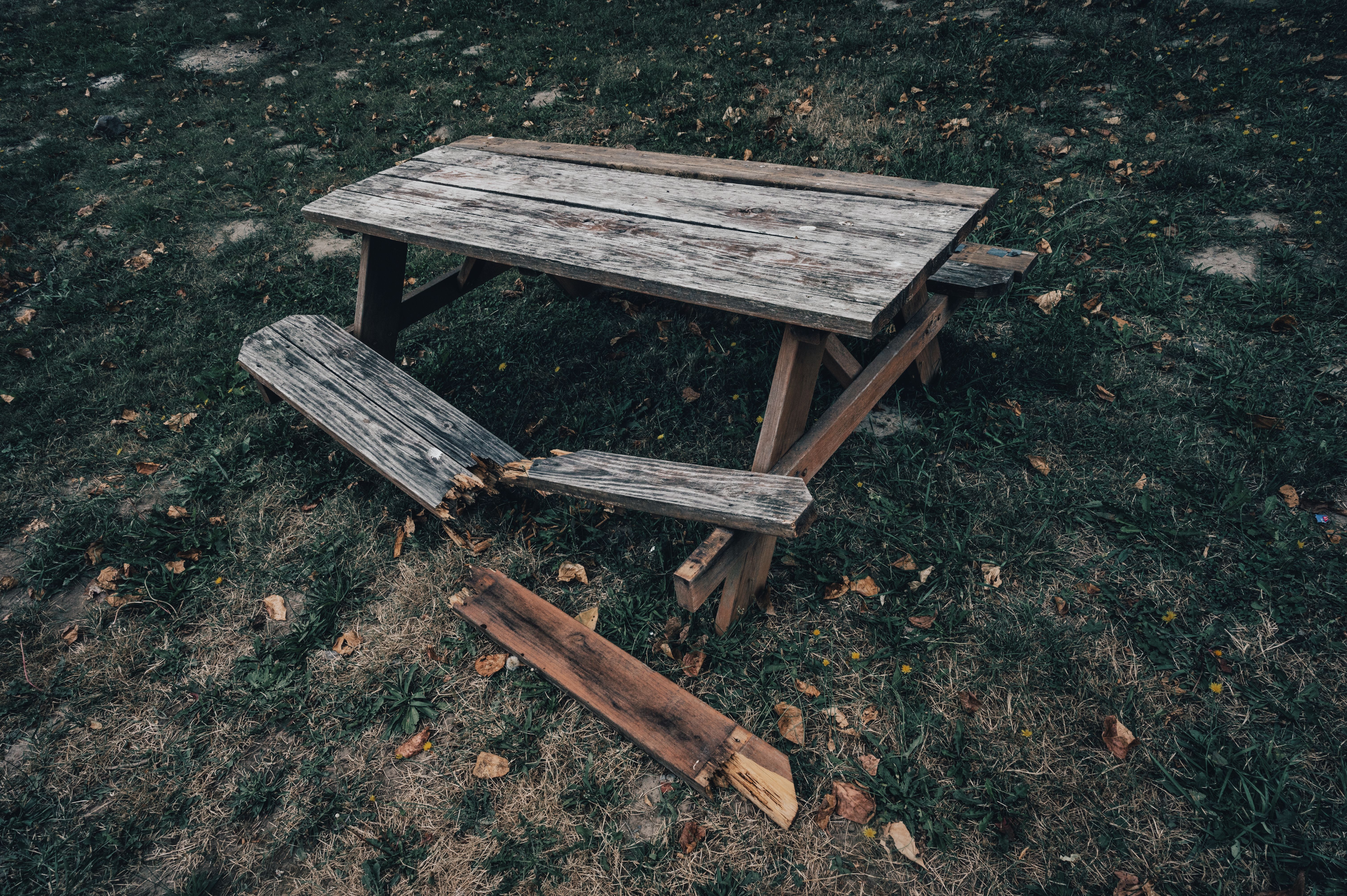 A broken picnic table in the grass · Free Stock Photo