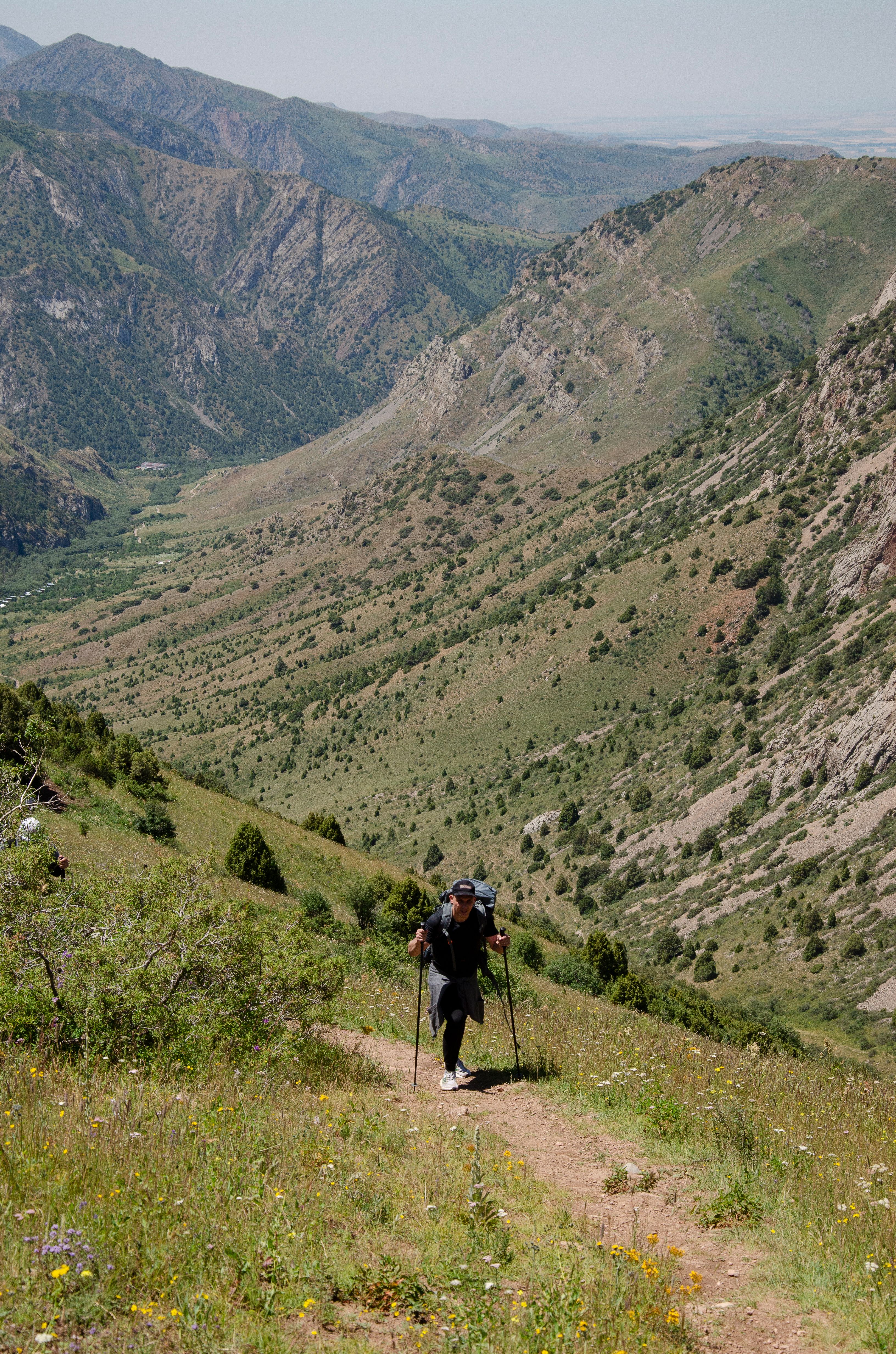 A person hiking up a steep trail in the mountains · Free Stock Photo
