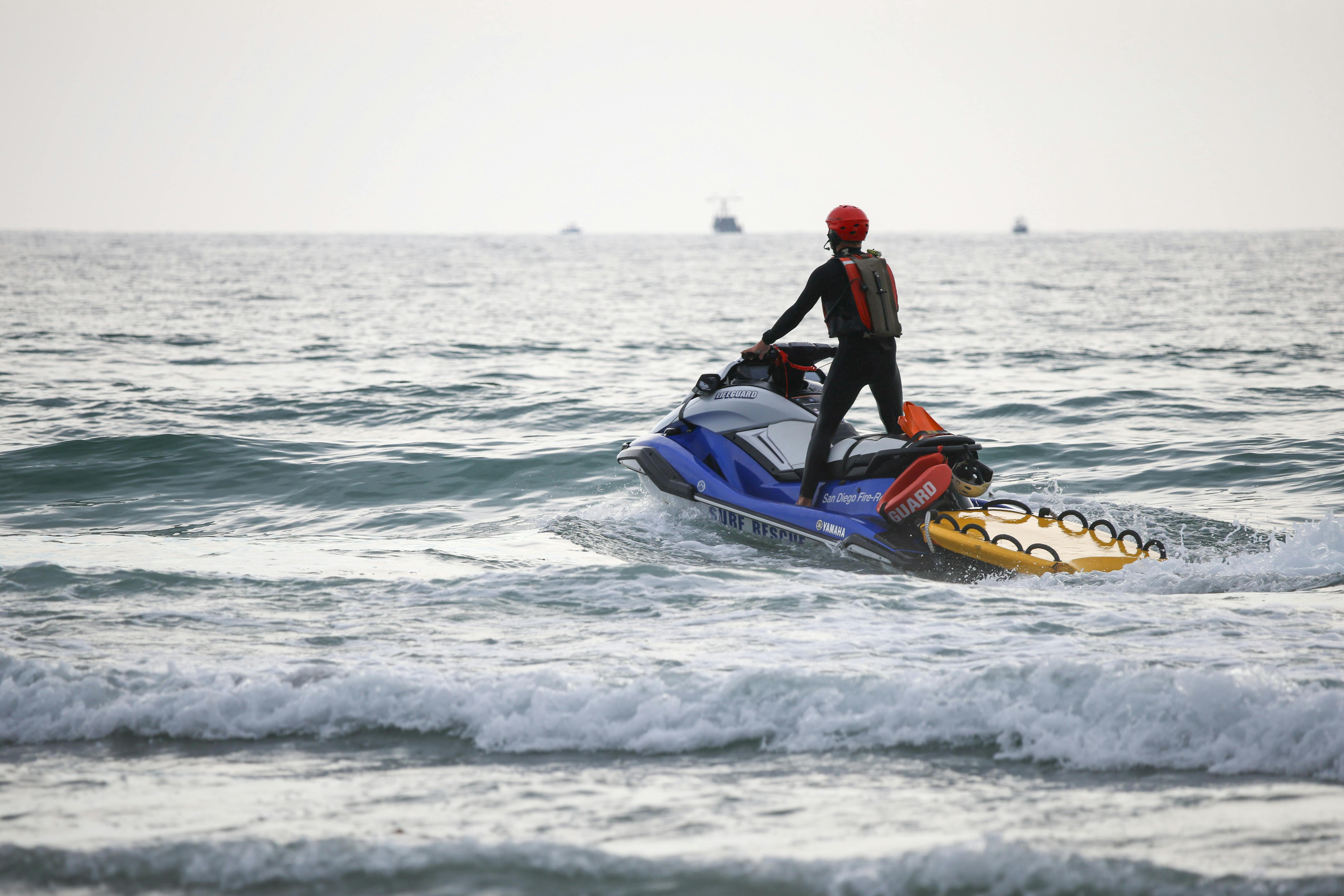 A person riding a jet ski in the ocean · Free Stock Photo