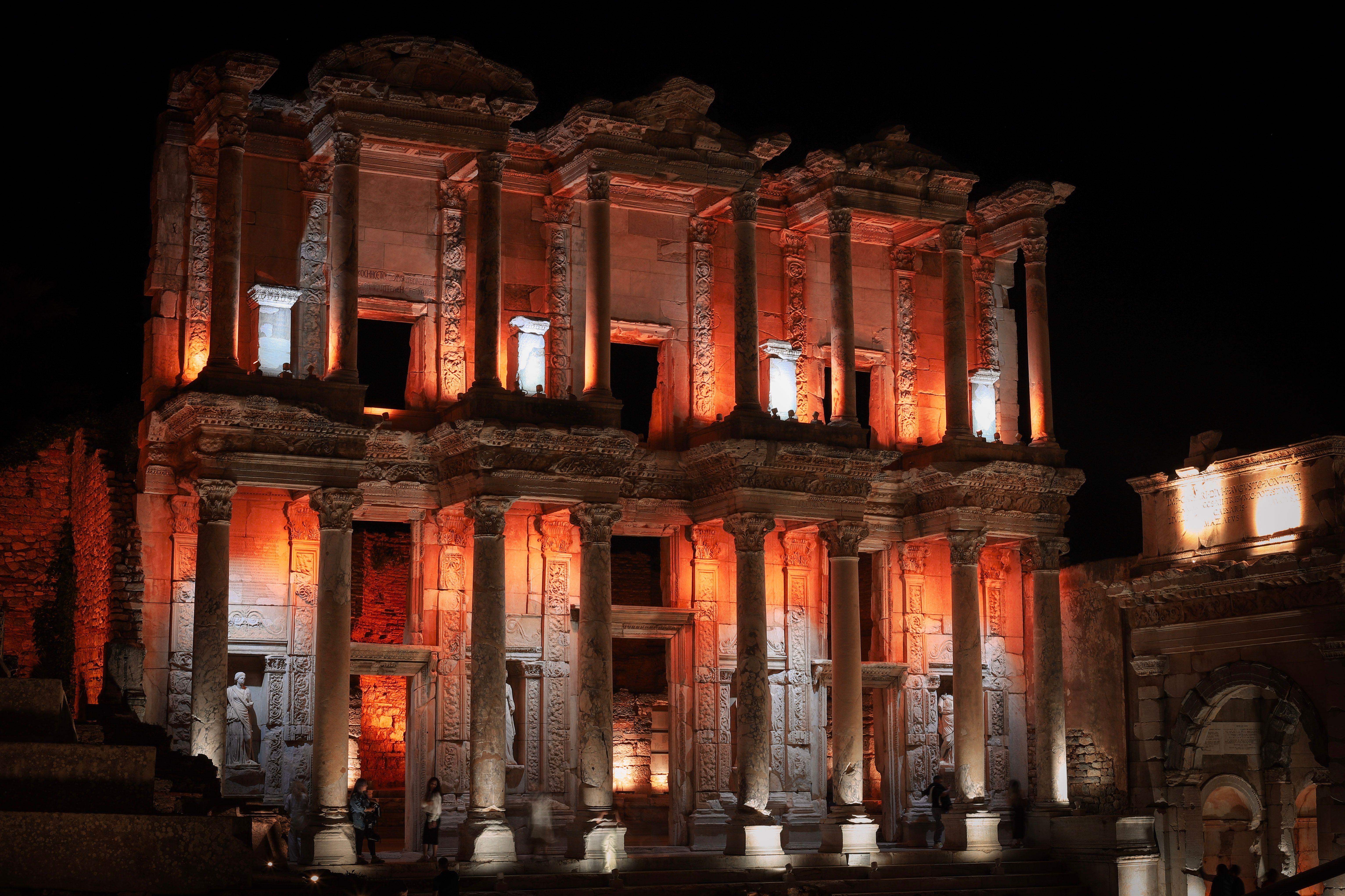 The ancient building is lit up with orange lights · Free Stock Photo