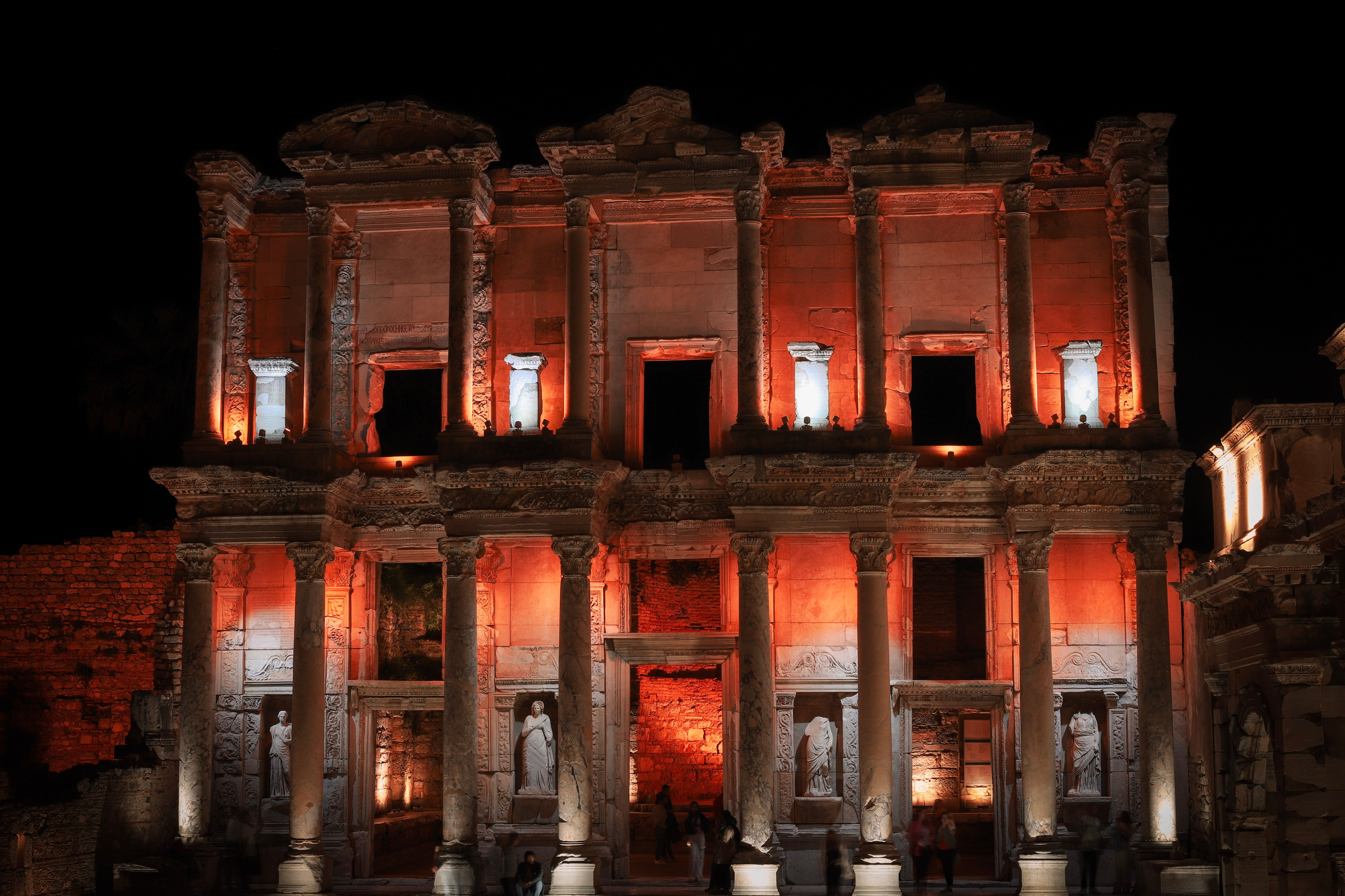 The ancient building is lit up with red lights · Free Stock Photo
