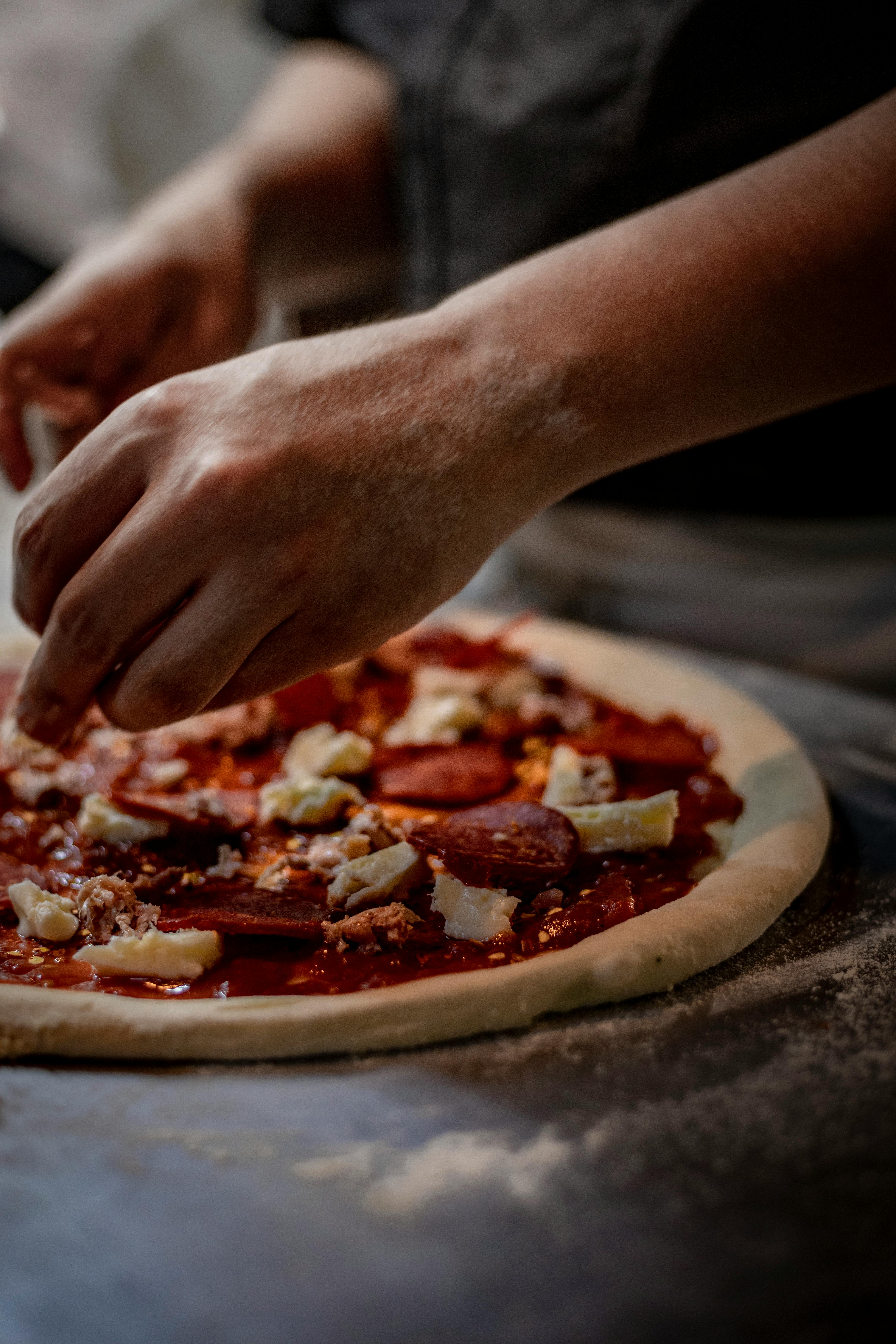 Photo Of Person Making A Pizza · Free Stock Photo