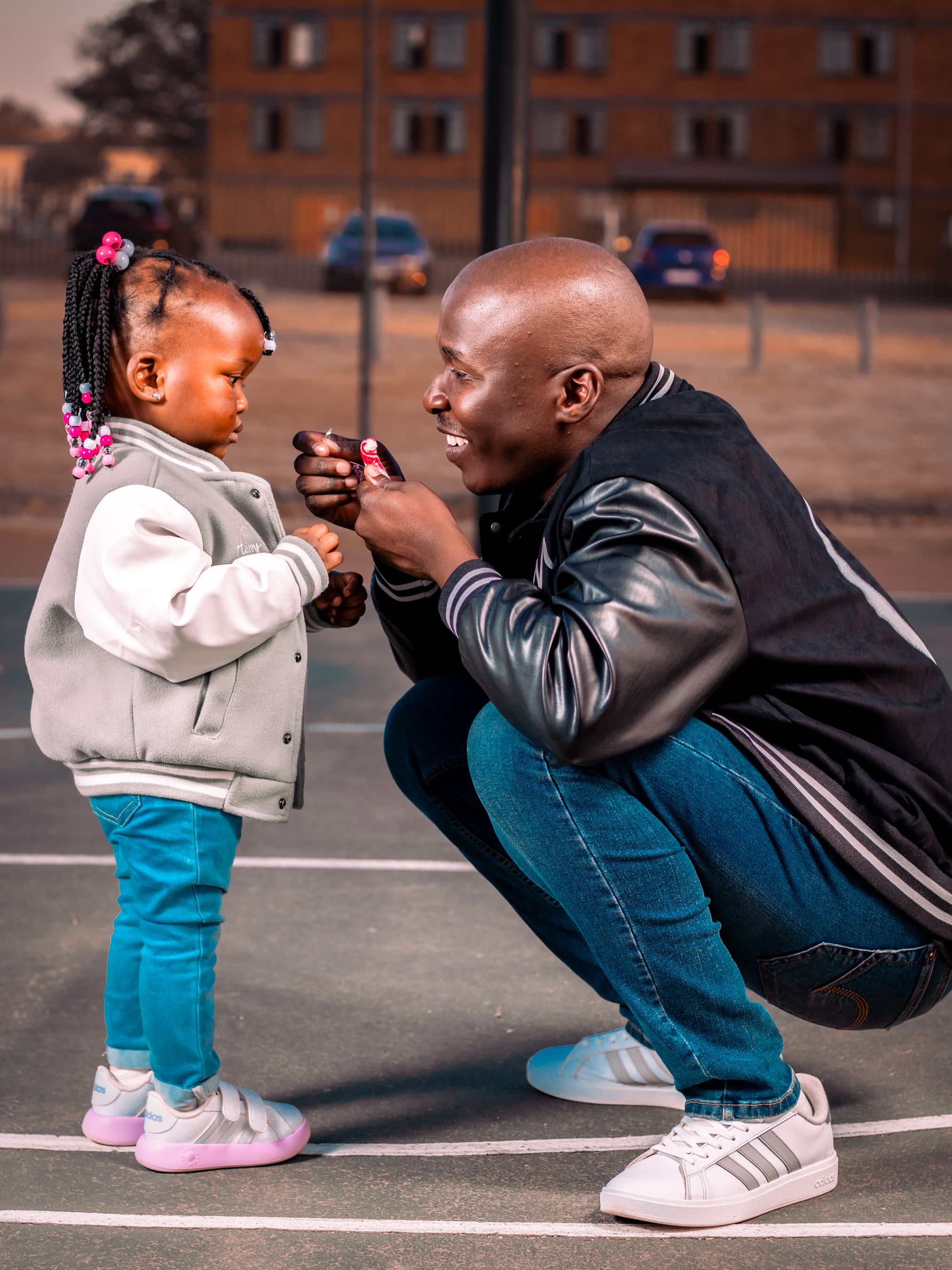 A man kneeling down to talk to a little girl · Free Stock Photo