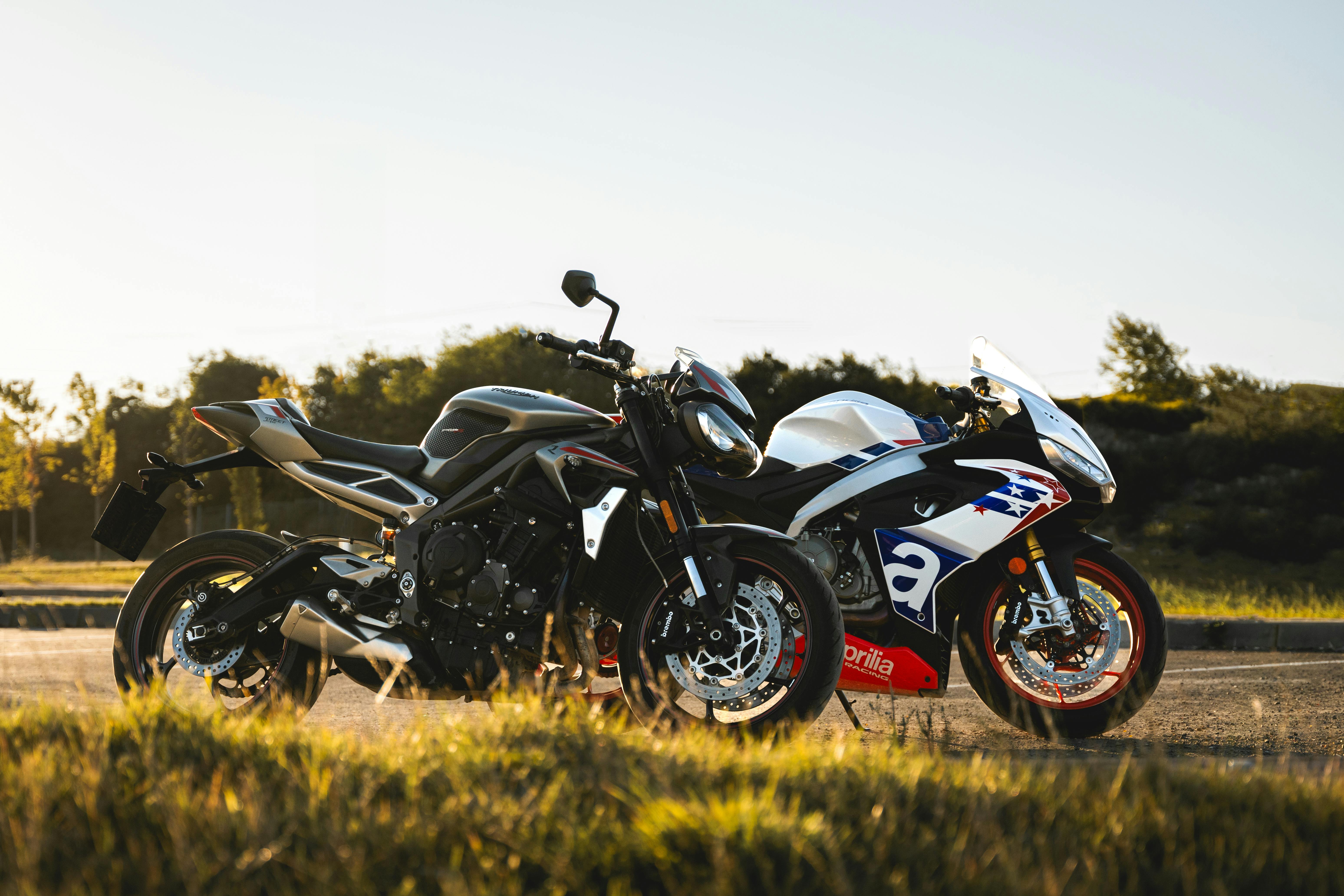 Two motorcycles parked on a grassy field · Free Stock Photo