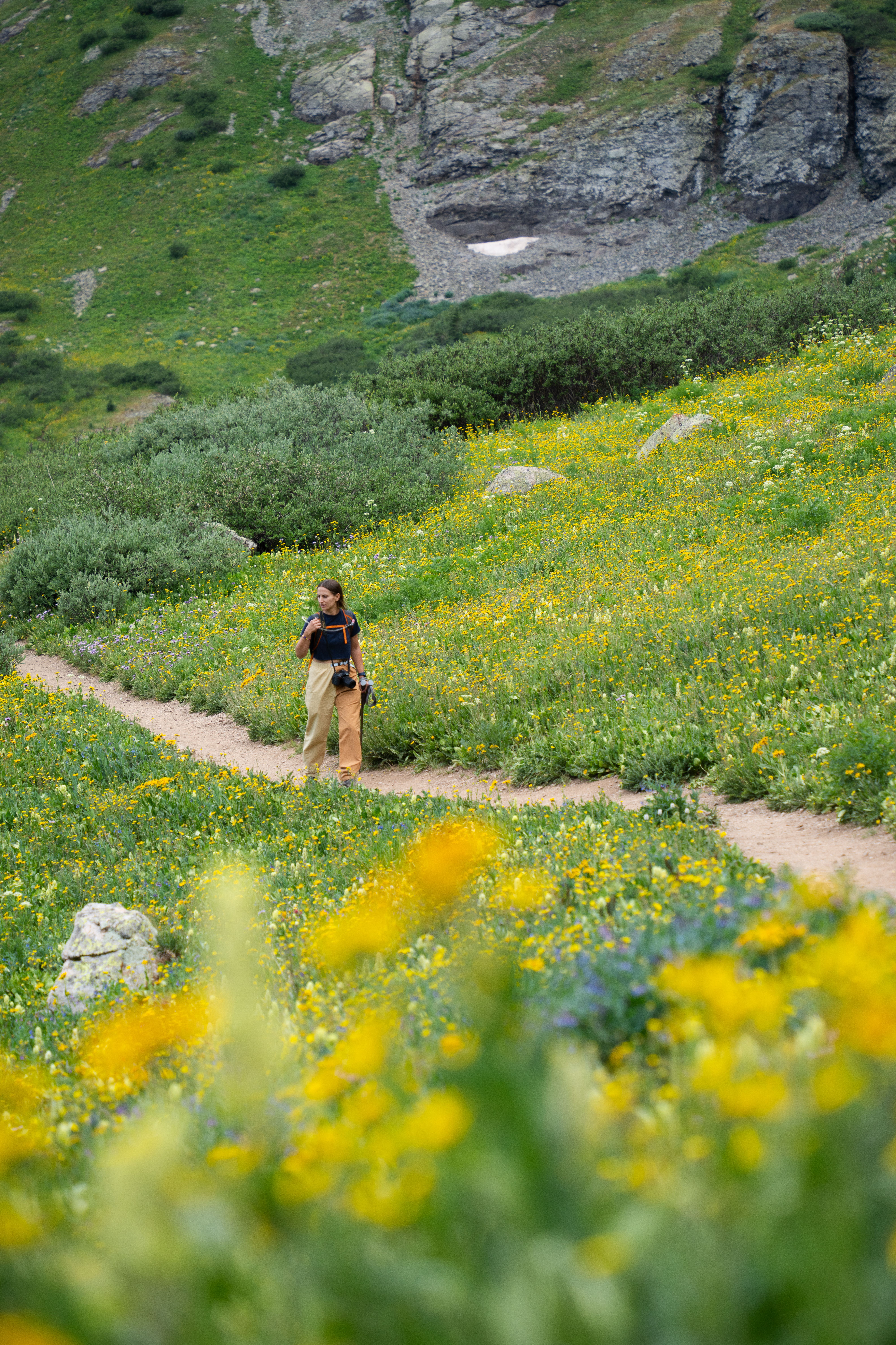 A woman running on a trail through a field of wildflowers · Free Stock ...