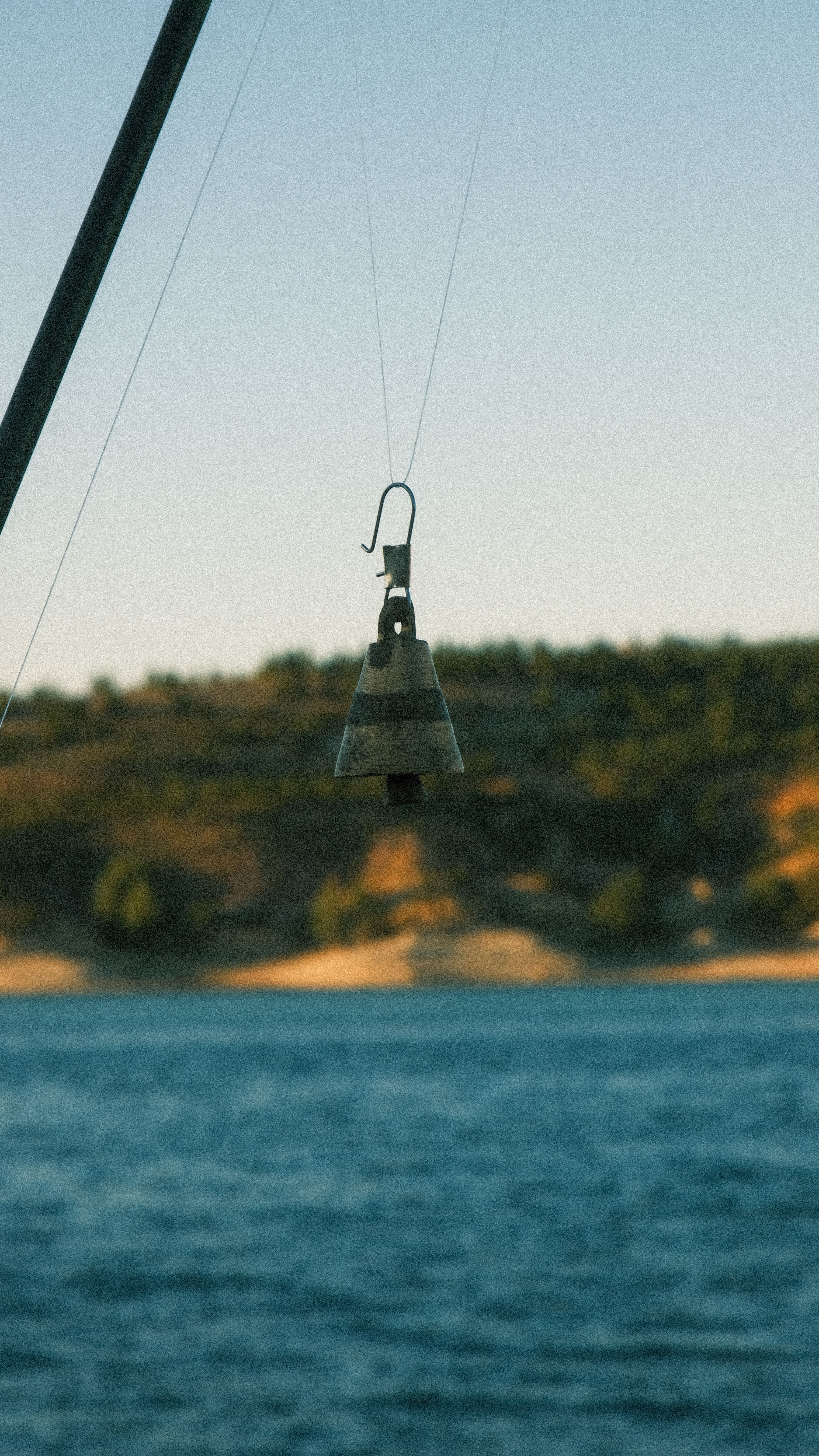 A bell hanging from a boat's mast · Free Stock Photo