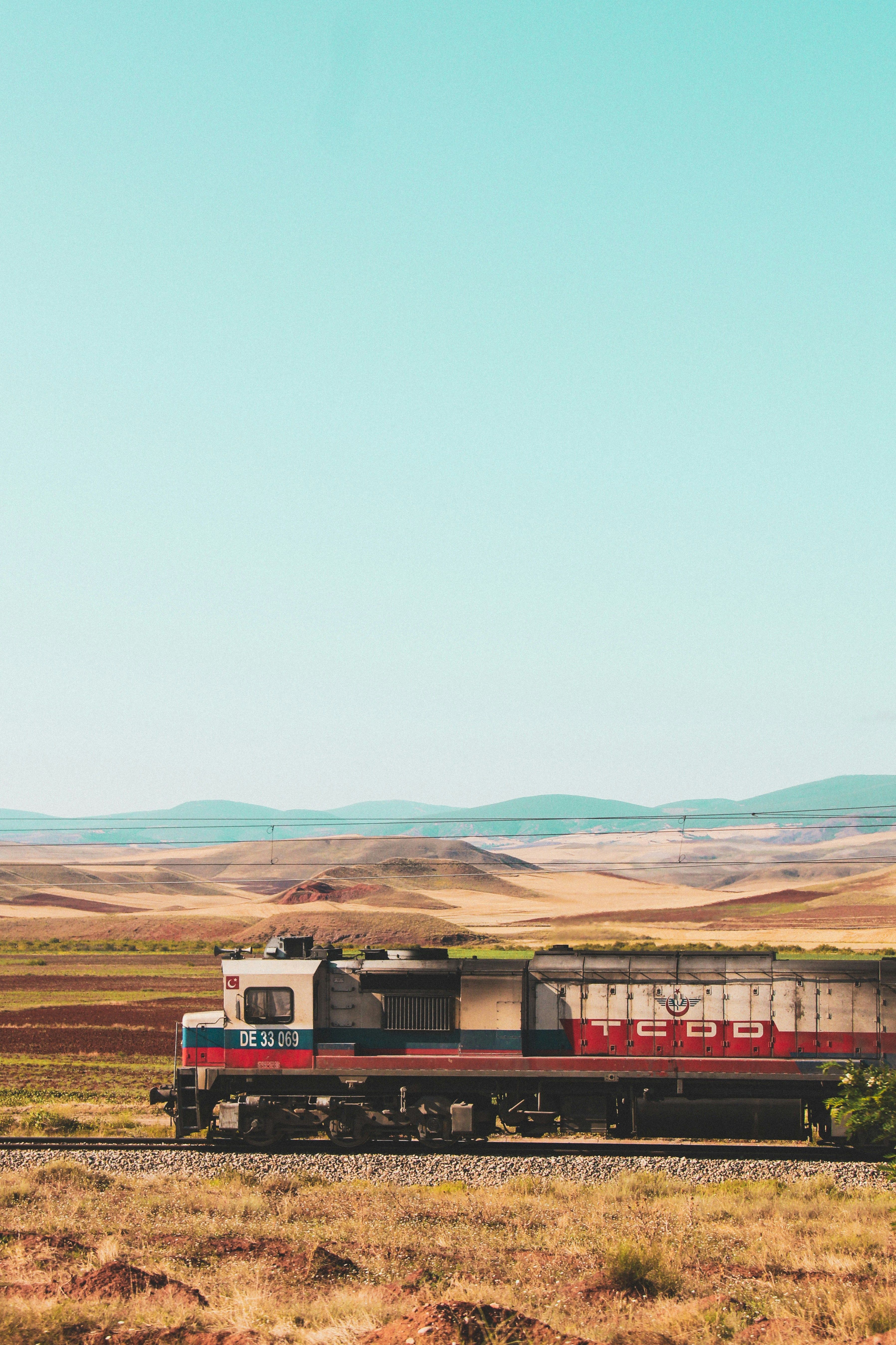 A train traveling through the desert on a track · Free Stock Photo