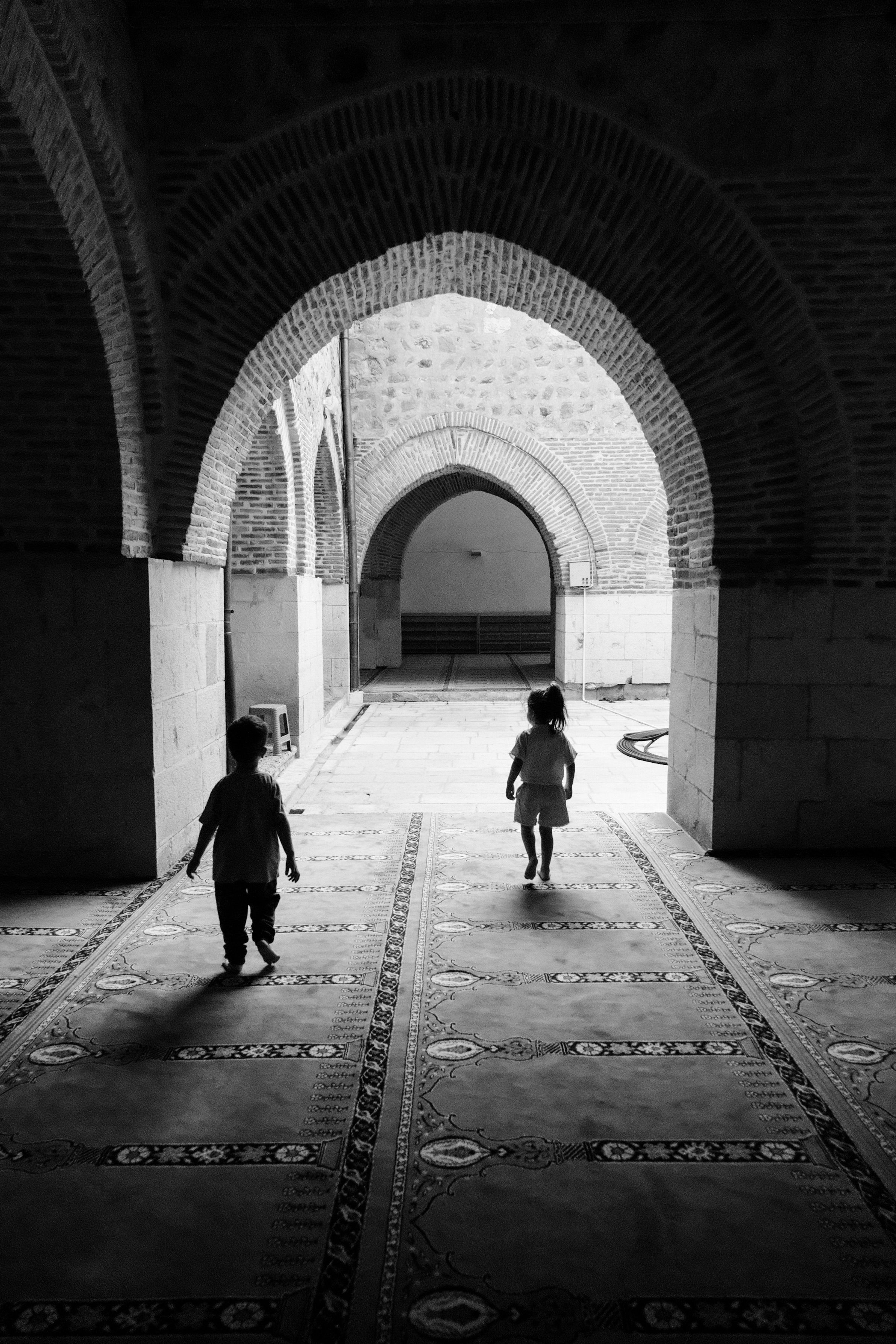 Girl Standing in Vintage Building Entrance · Free Stock Photo