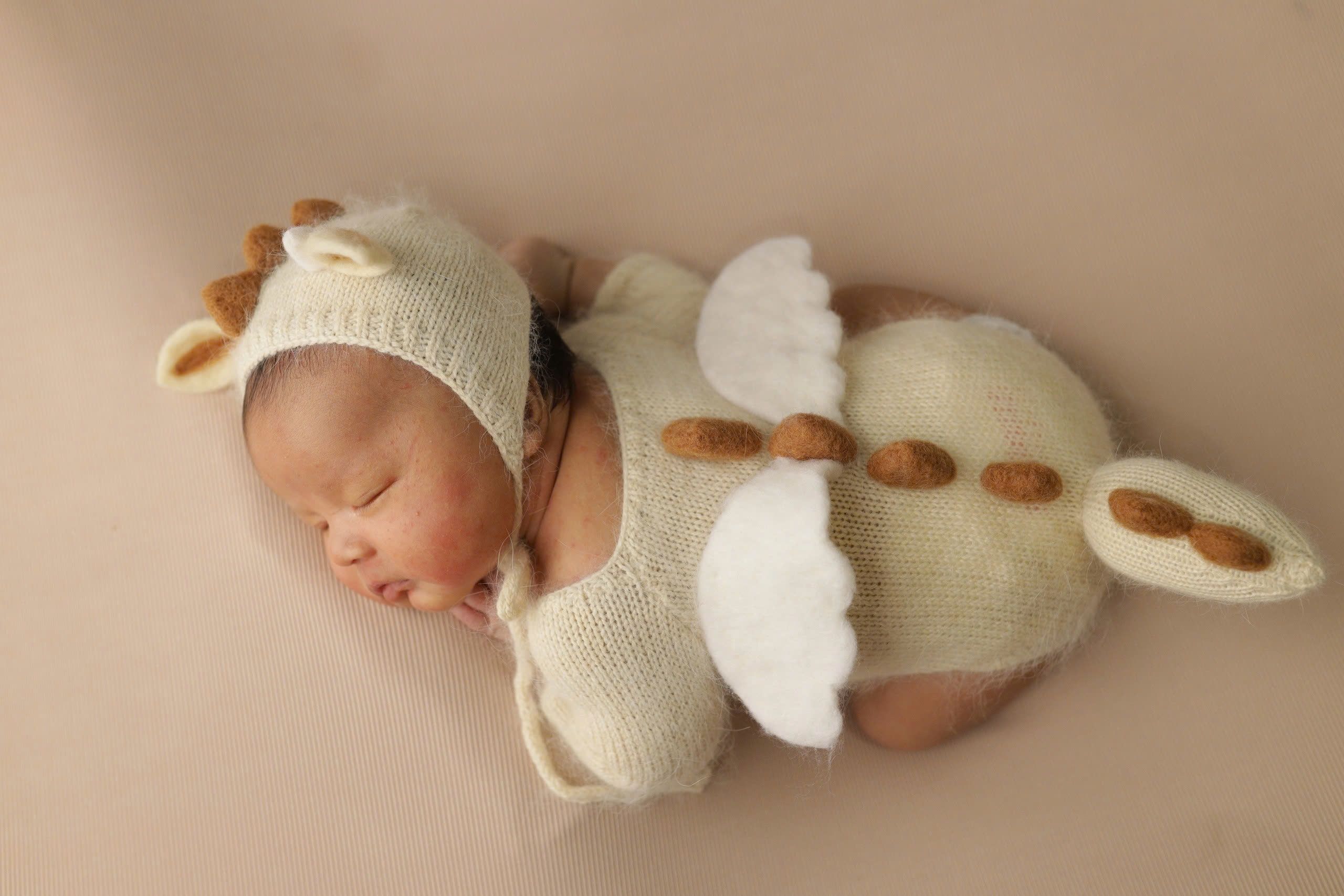 A newborn baby is wearing a knitted costume · Free Stock Photo