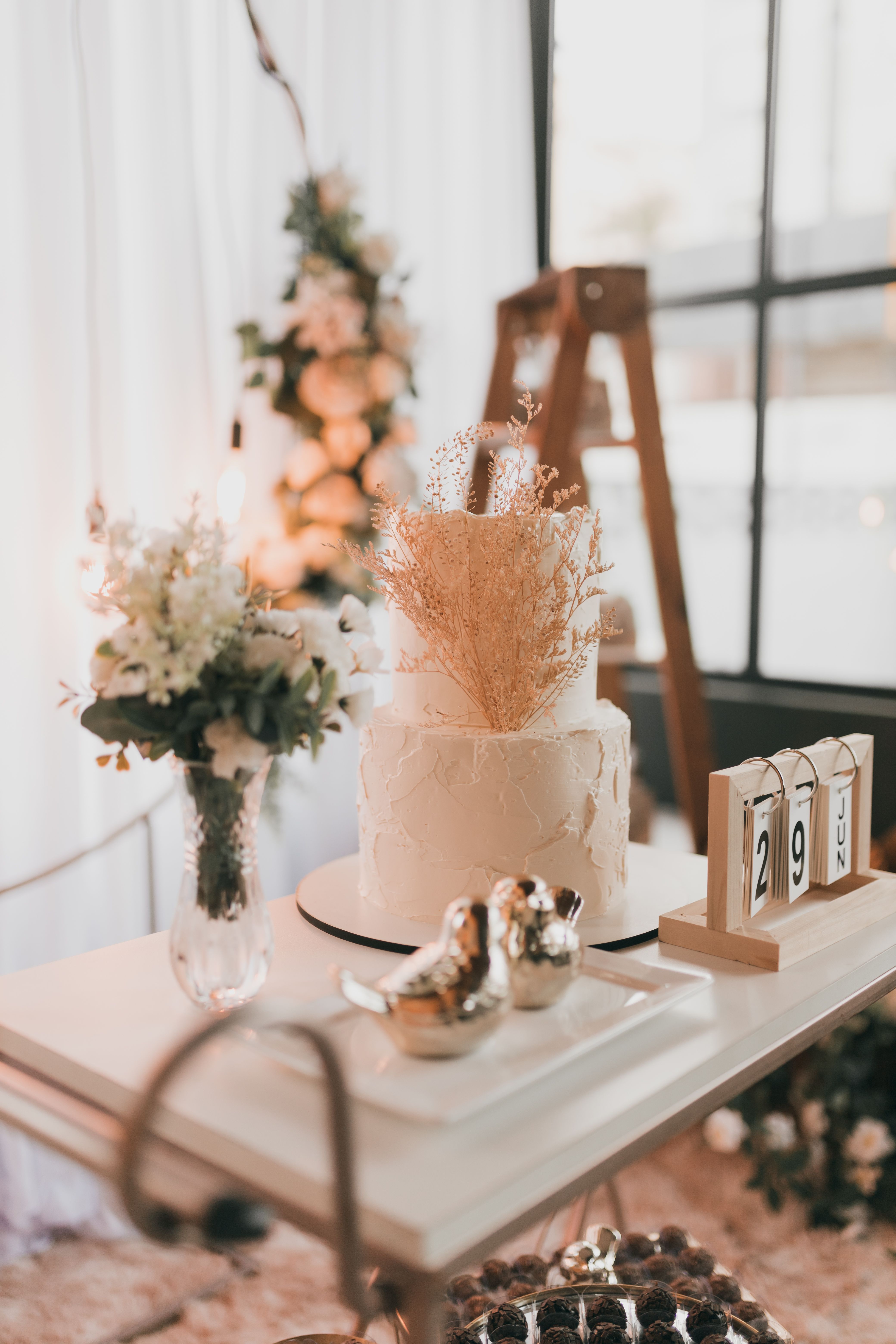 A wedding cake on a table with a ladder · Free Stock Photo