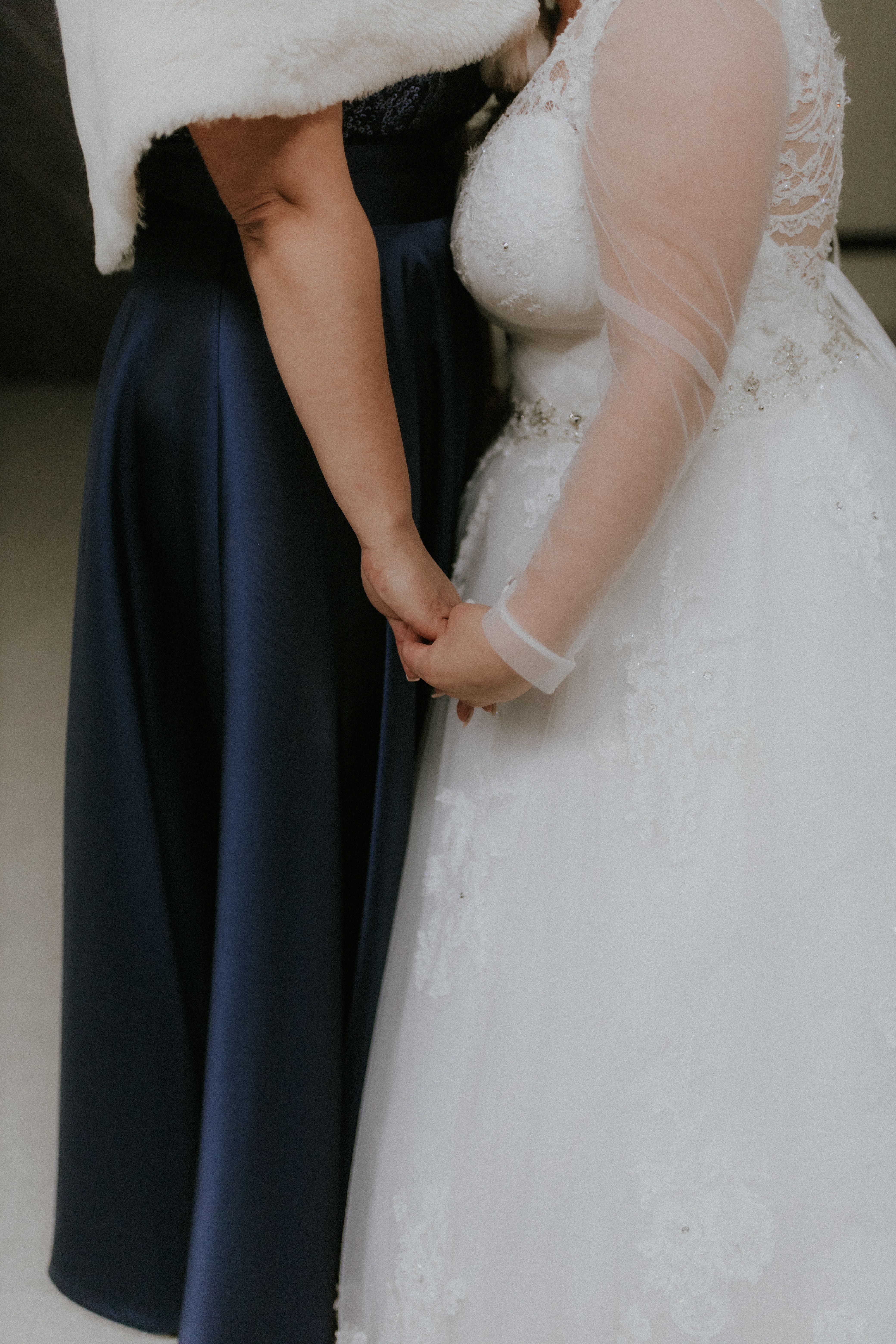 Two women in wedding dresses hugging each other · Free Stock Photo