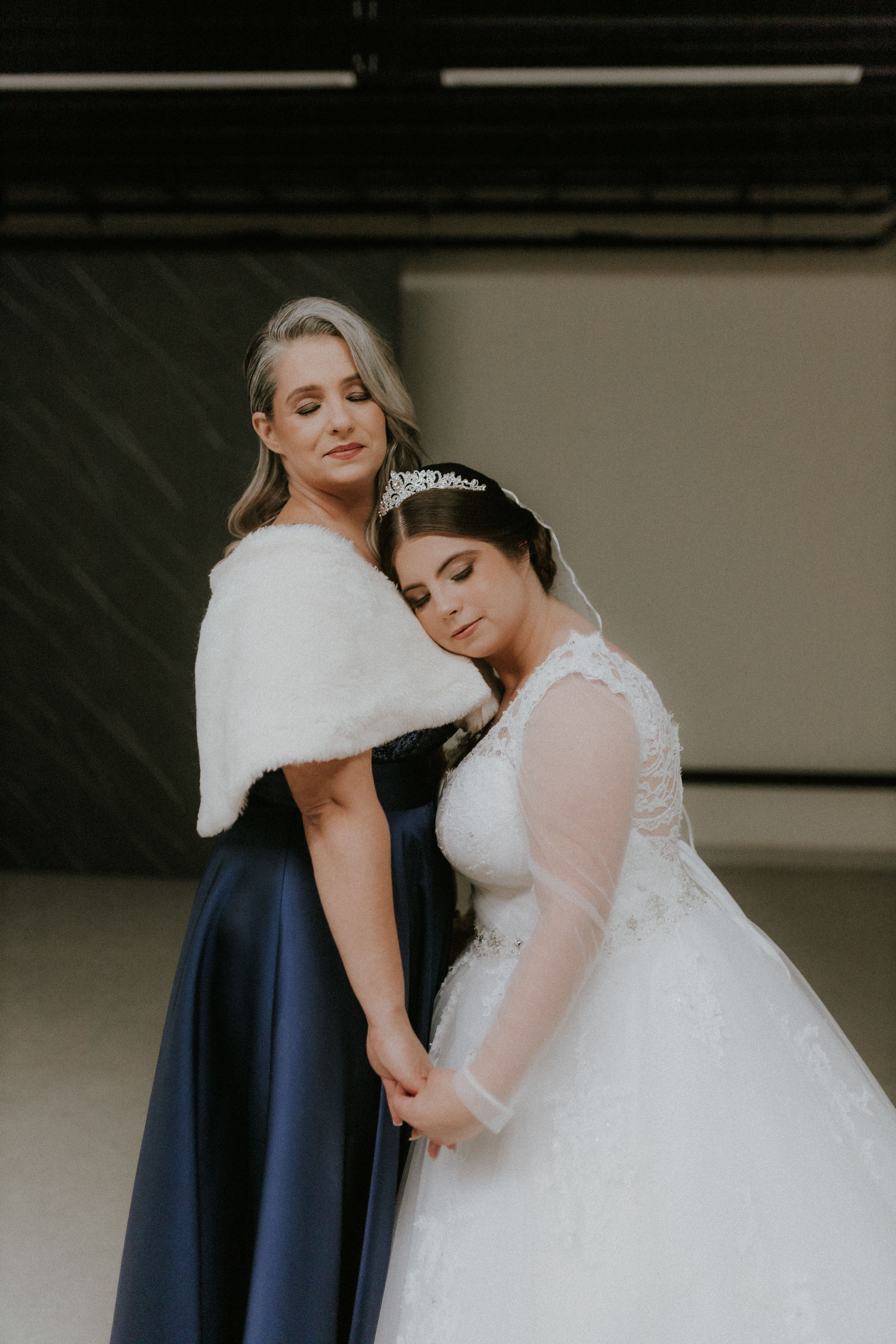 Two women in wedding dresses hugging each other · Free Stock Photo