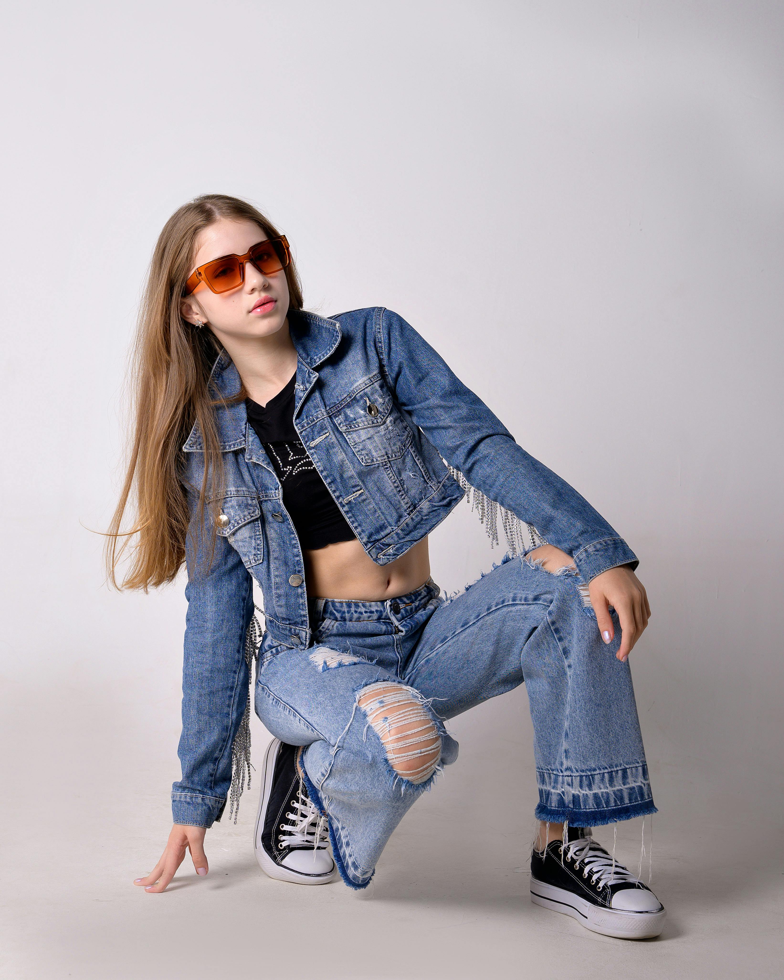 Young Model in a Pink T-shirt and Jeans Posing in the Studio · Free ...