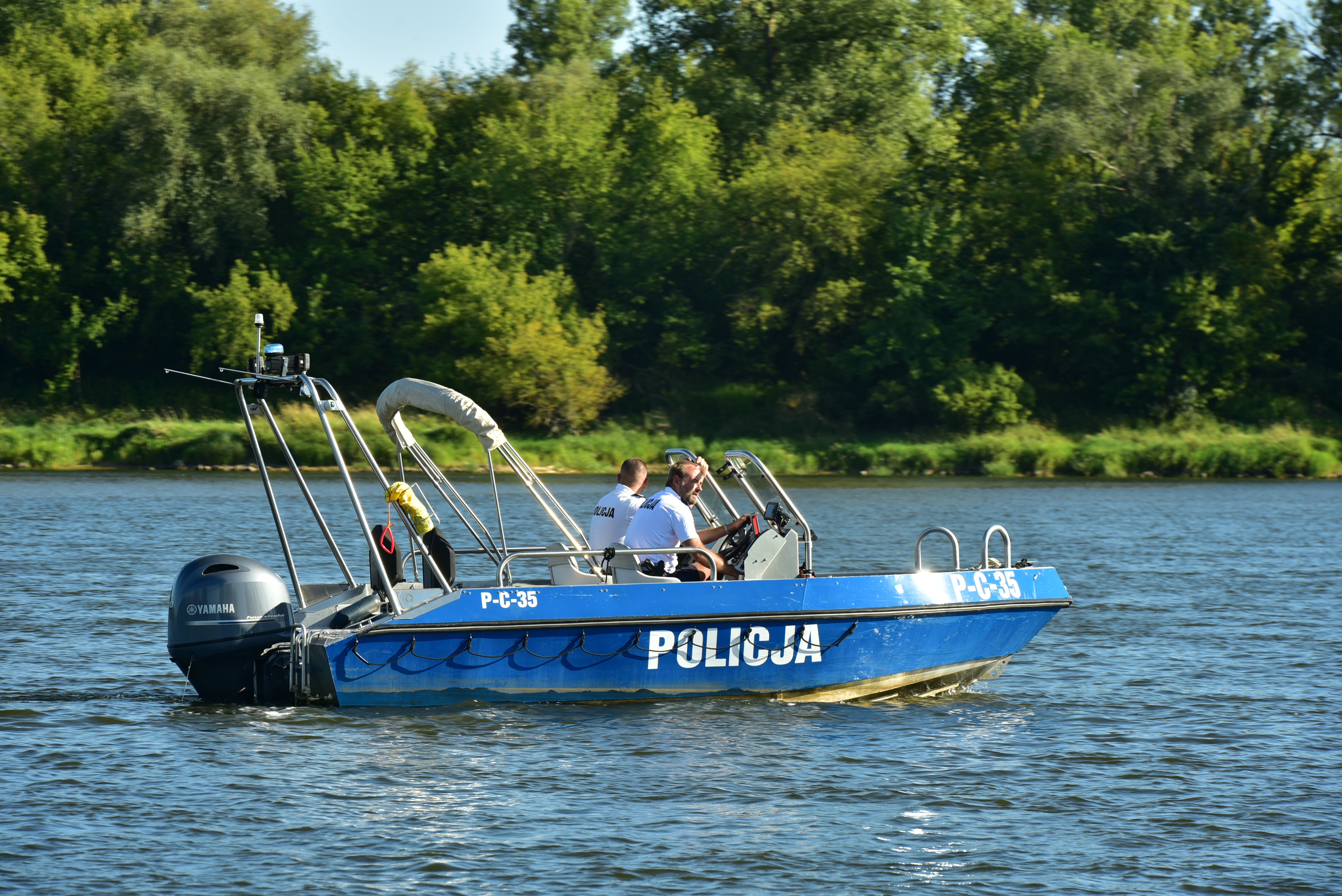 A police boat on the water with two people on it · Free Stock Photo