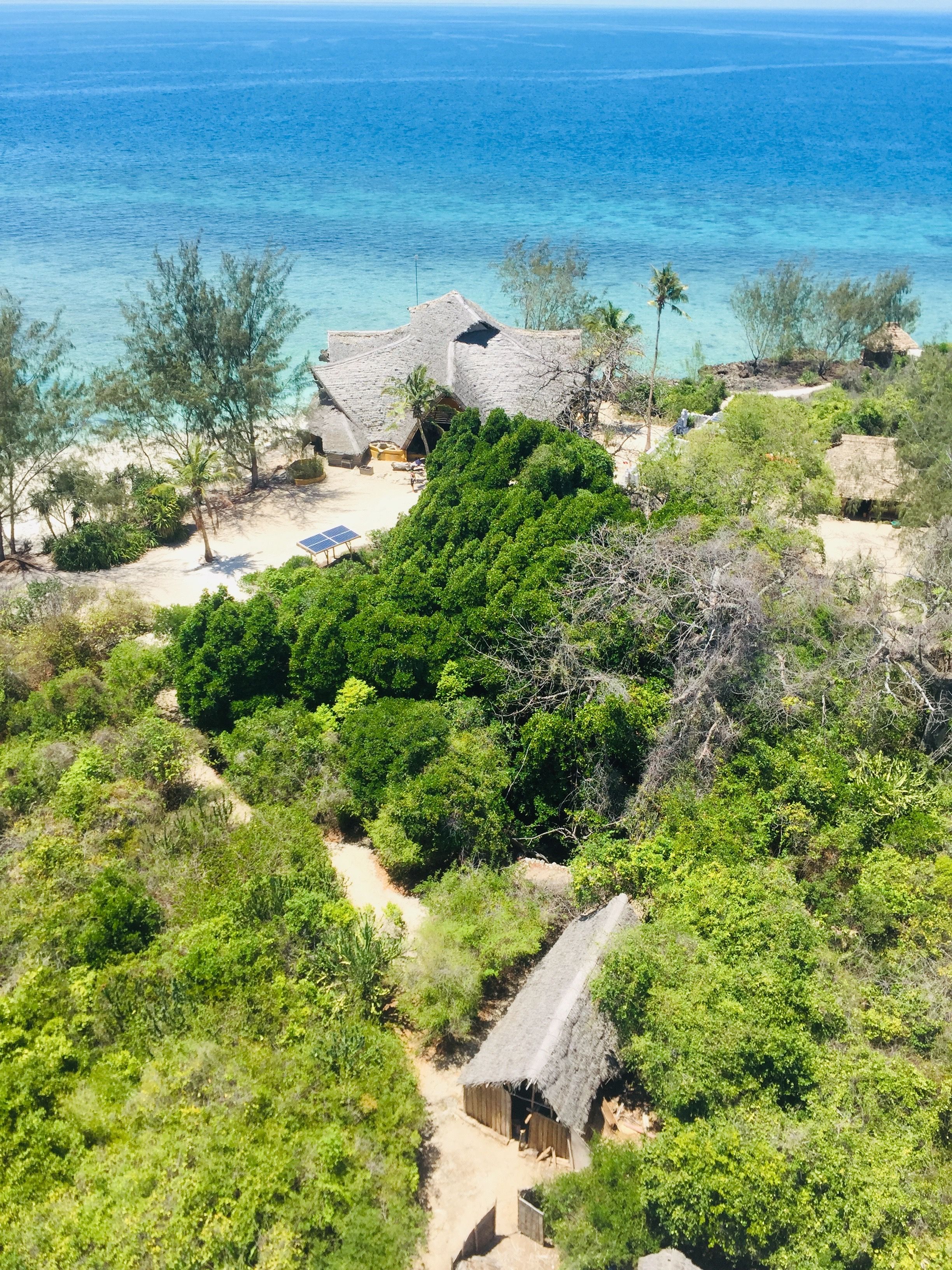 An aerial view of a beach and a small hut · Free Stock Photo