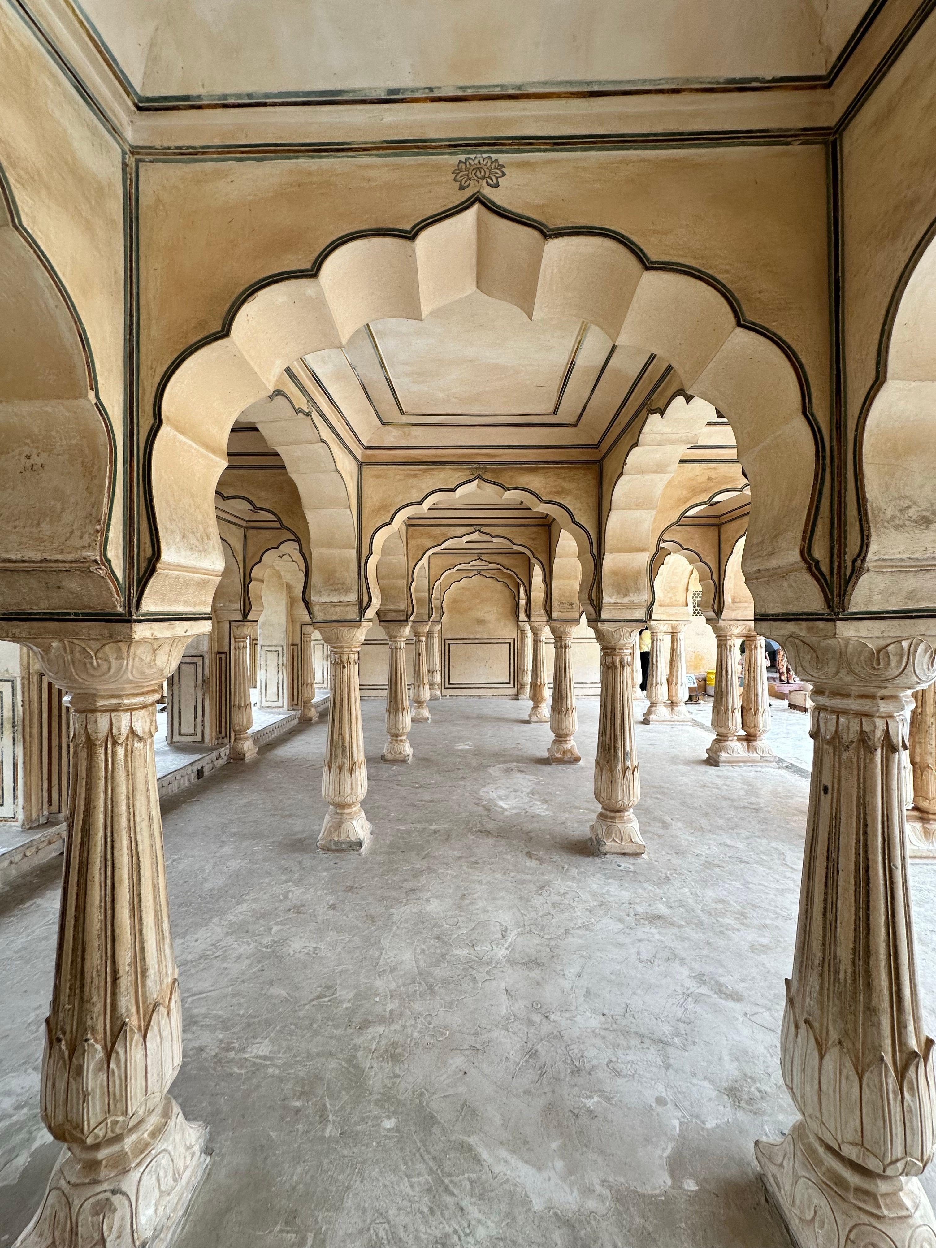 The inside of an old building with columns and arches · Free Stock Photo