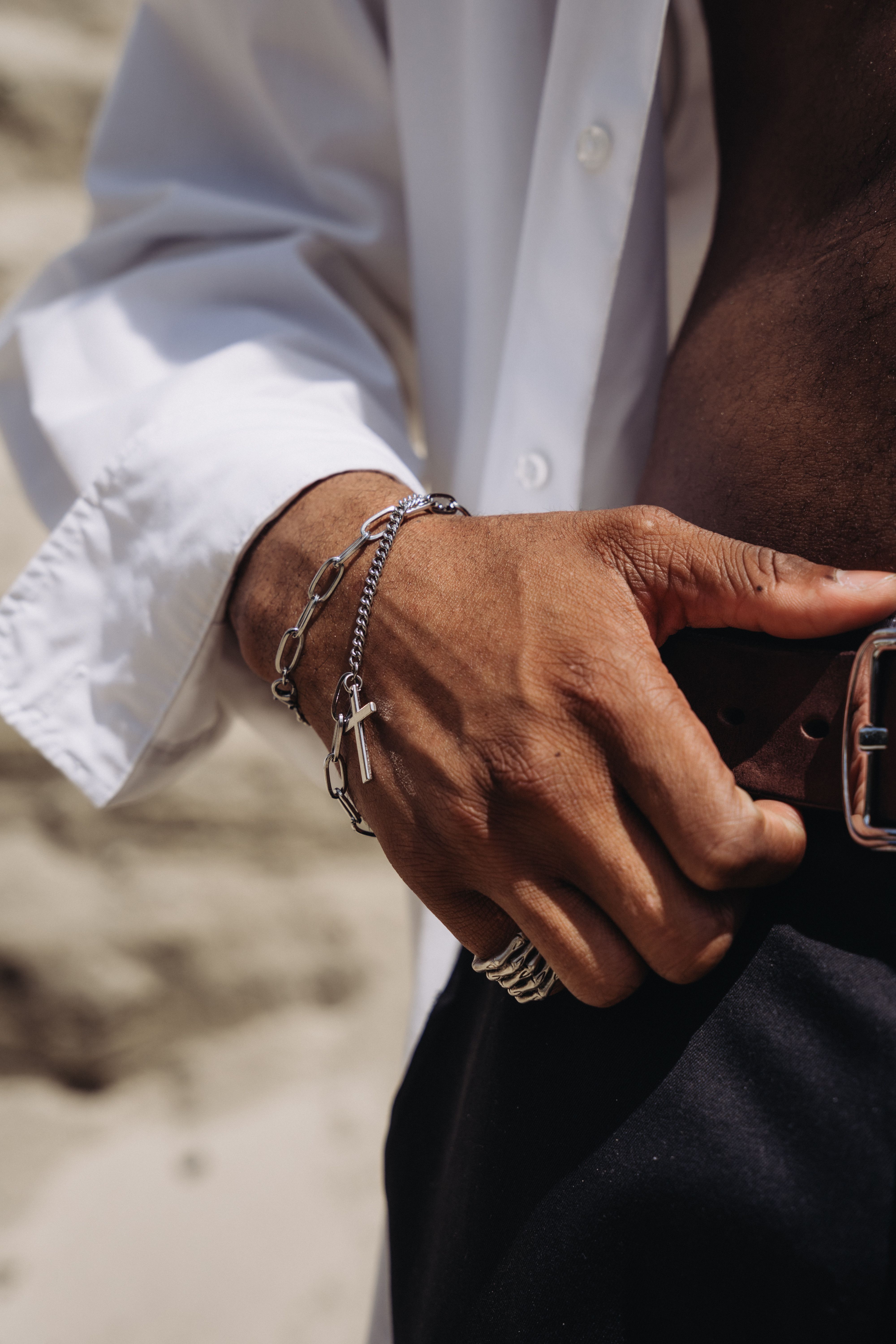 Bracelet and Cross on Hand of Man · Free Stock Photo