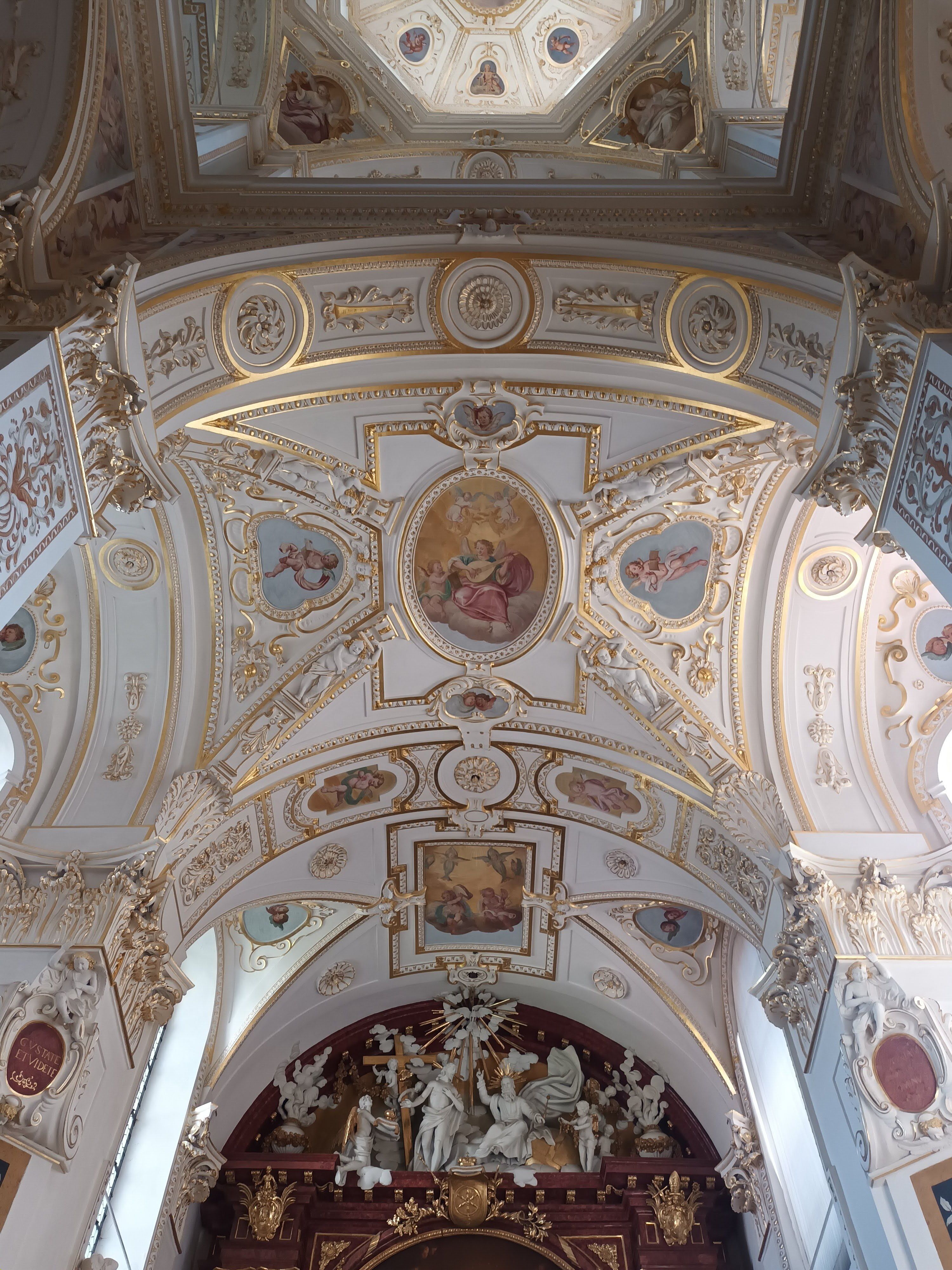 The ceiling of a church with paintings and gold · Free Stock Photo