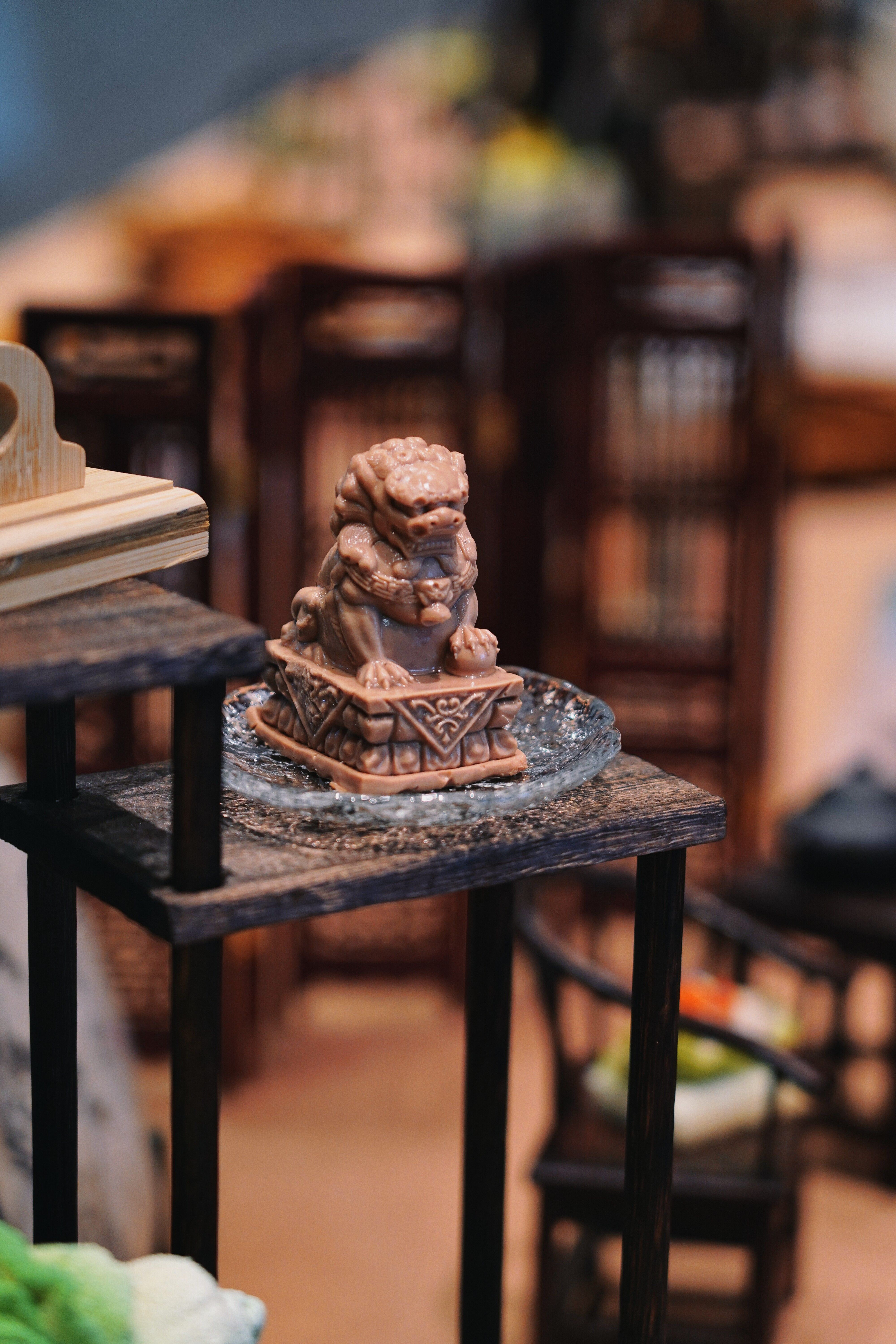 A small table with a statue on top of it · Free Stock Photo