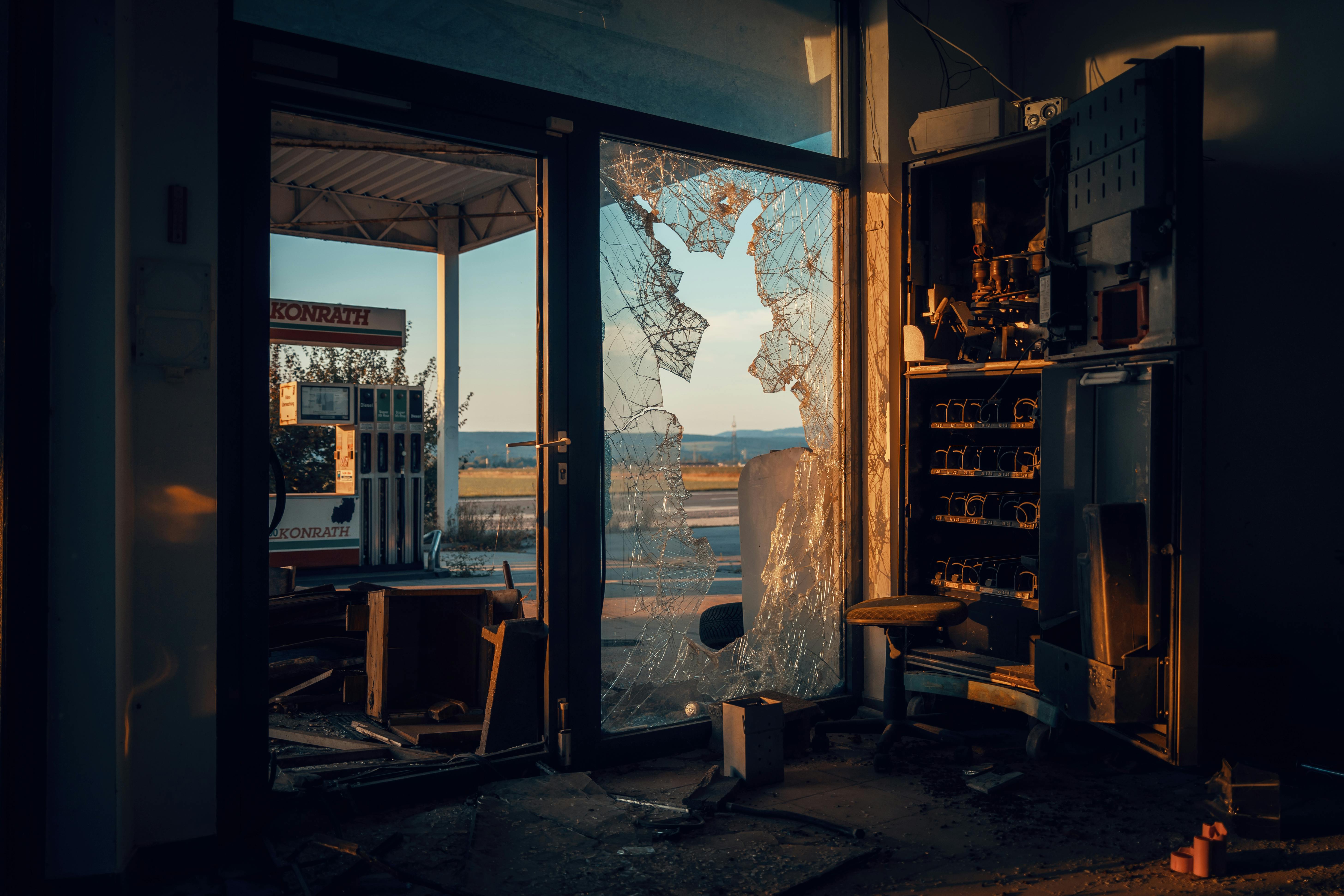 A broken window in a room with a broken door · Free Stock Photo