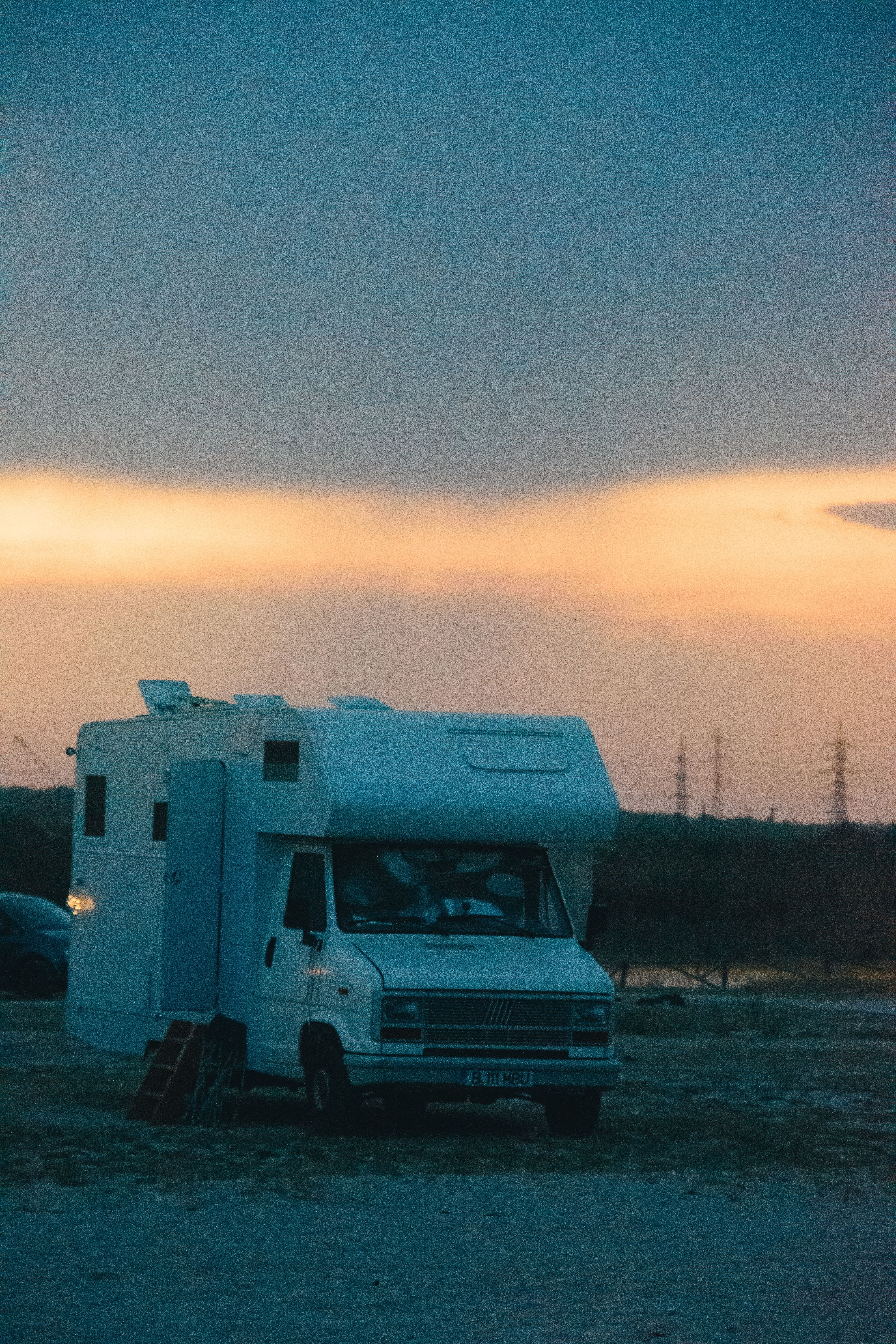 A rv parked in the desert at sunset · Free Stock Photo