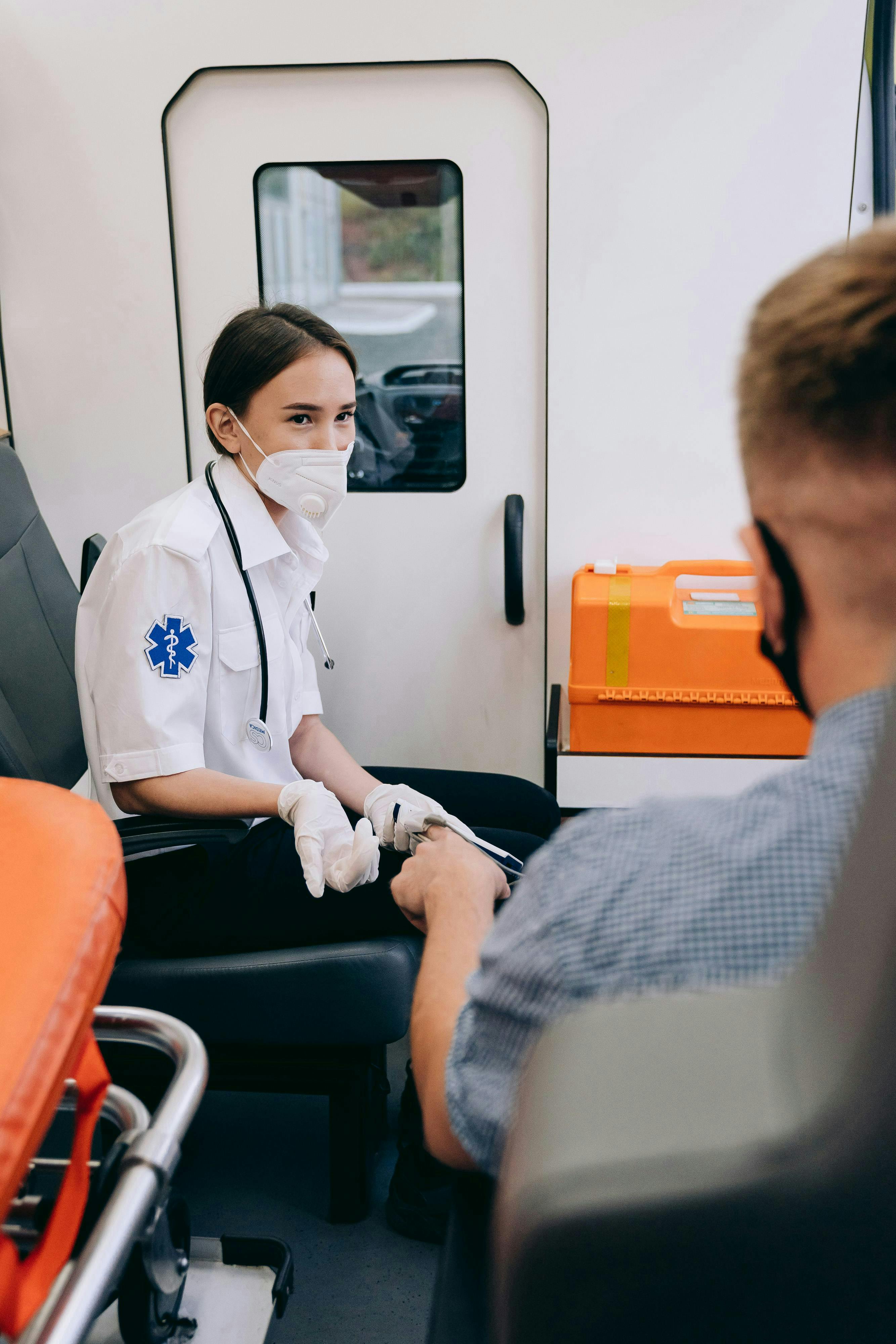 Medic in Shirt Sitting with Patient · Free Stock Photo
