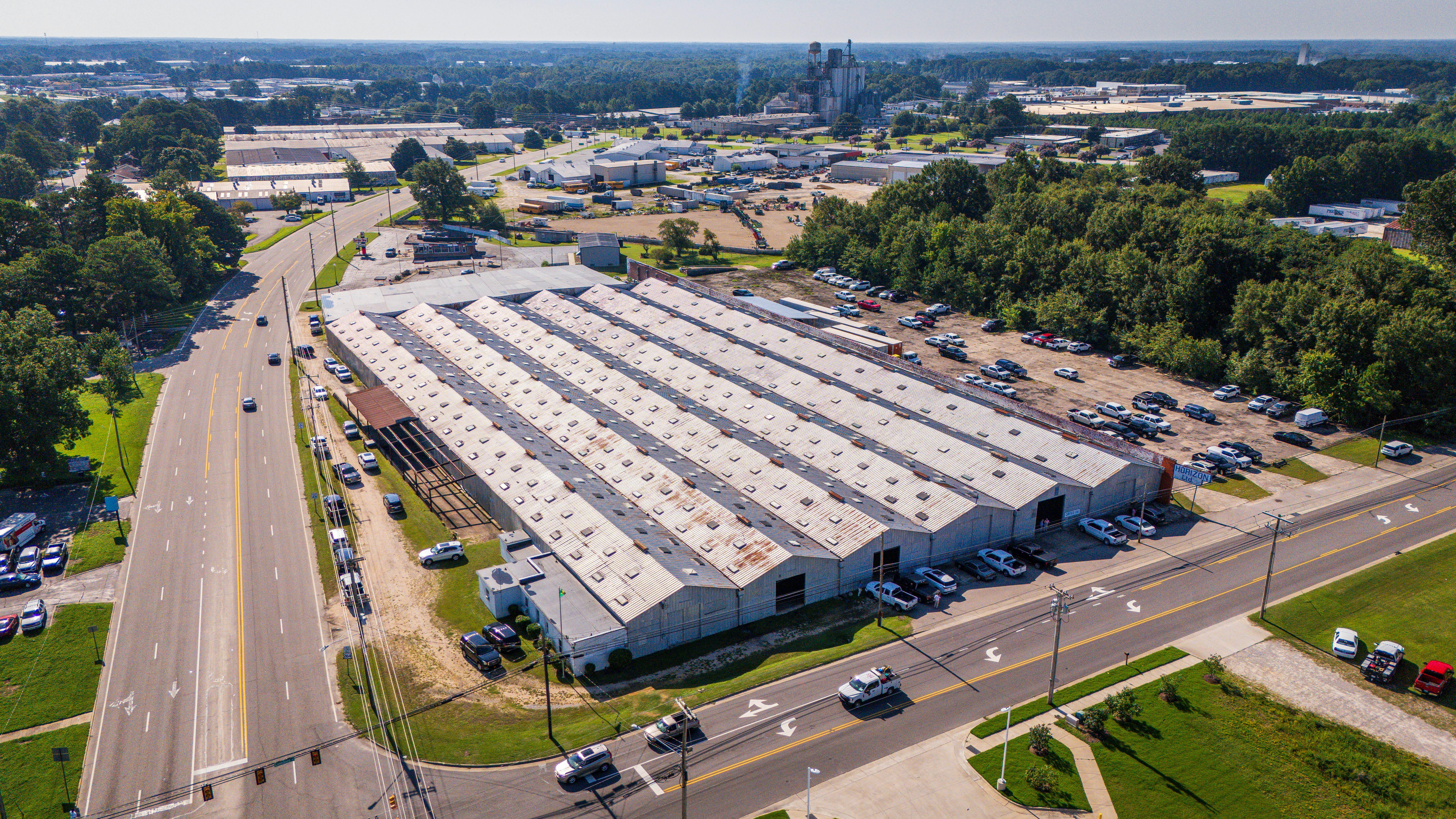 An aerial view of a warehouse with a large parking lot · Free Stock Photo