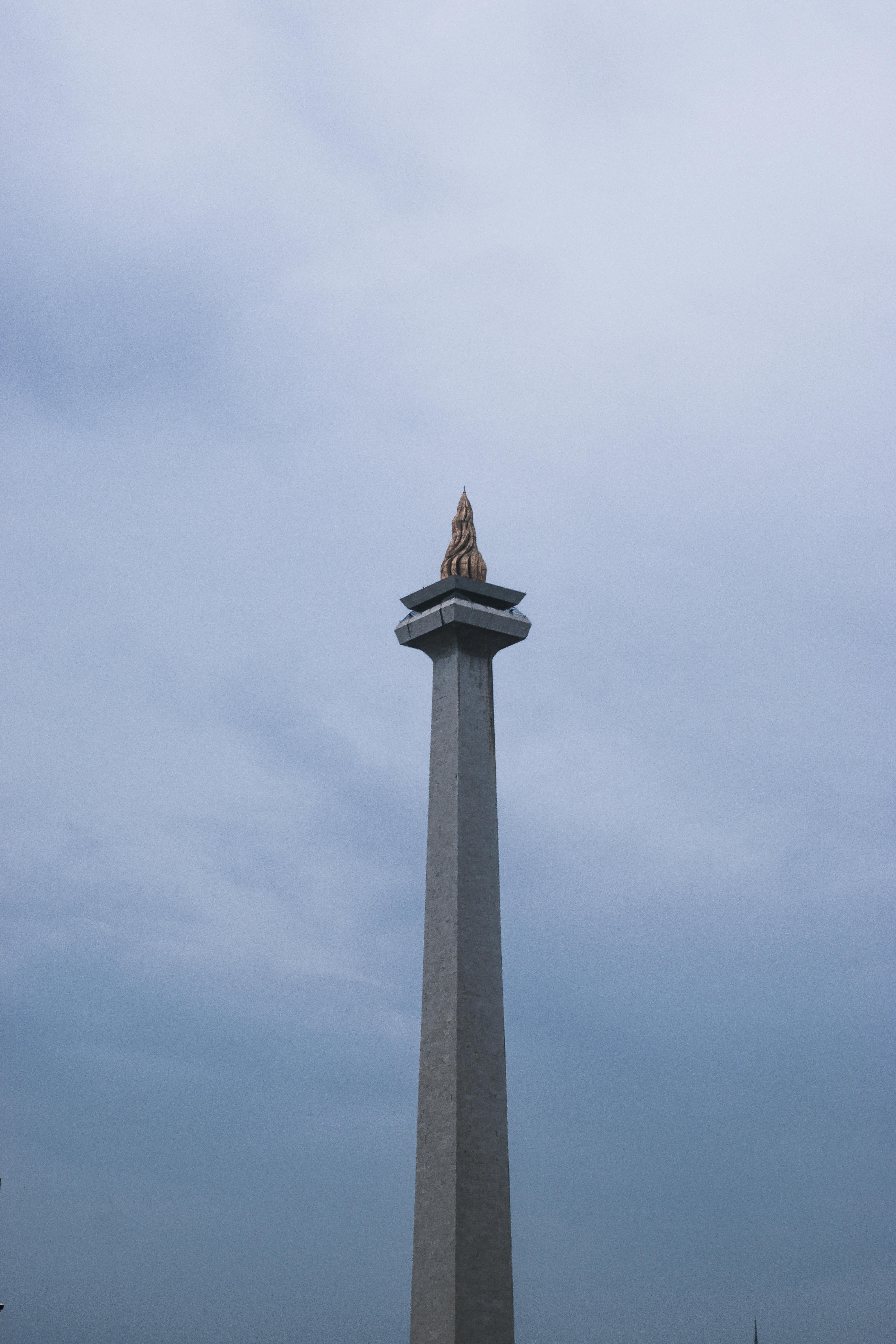 A tall monument with a clock on top · Free Stock Photo