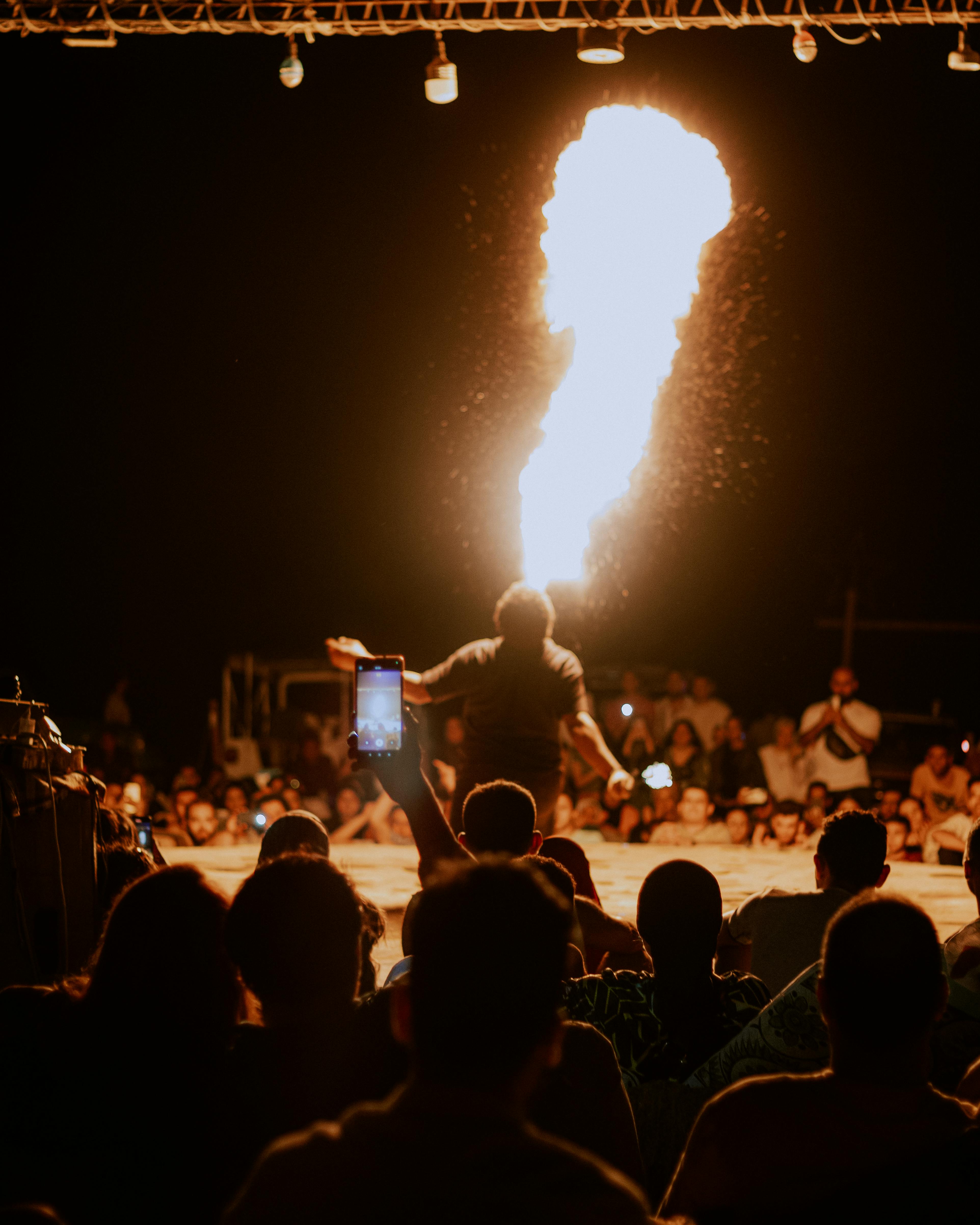 A man is performing a fire show on stage · Free Stock Photo