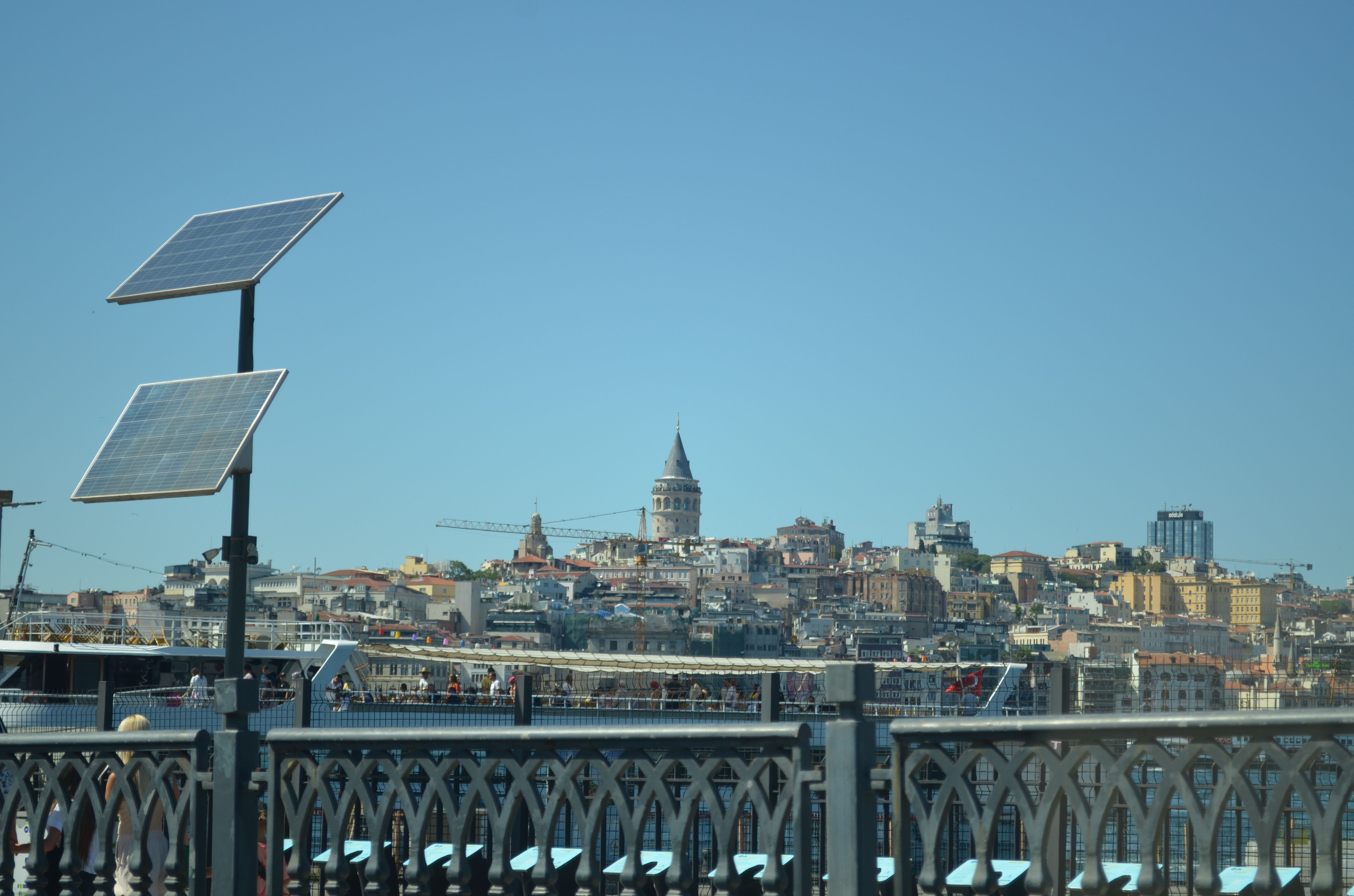 A solar panel on a bridge over a city · Free Stock Photo