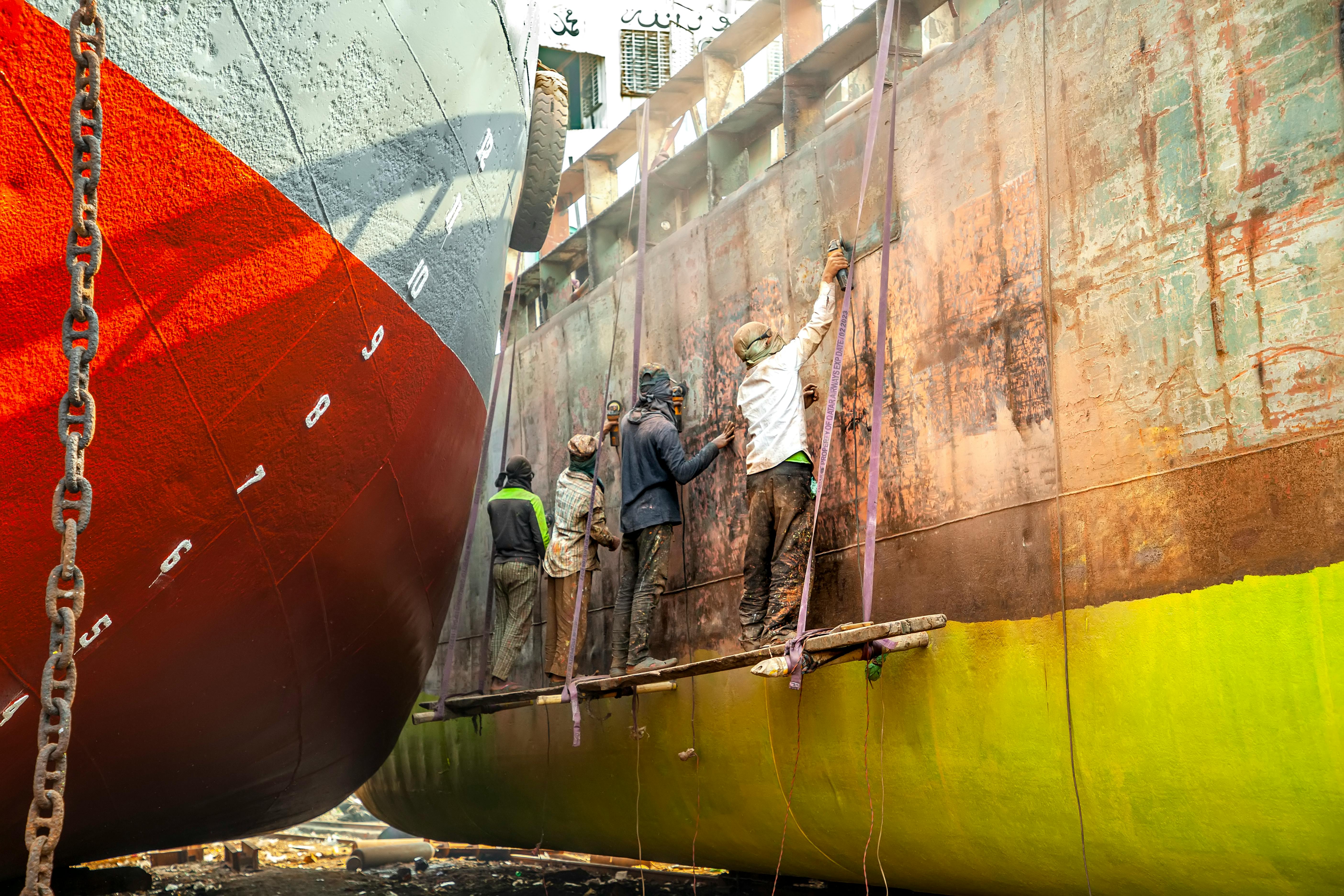 A group of men working on a large ship · Free Stock Photo