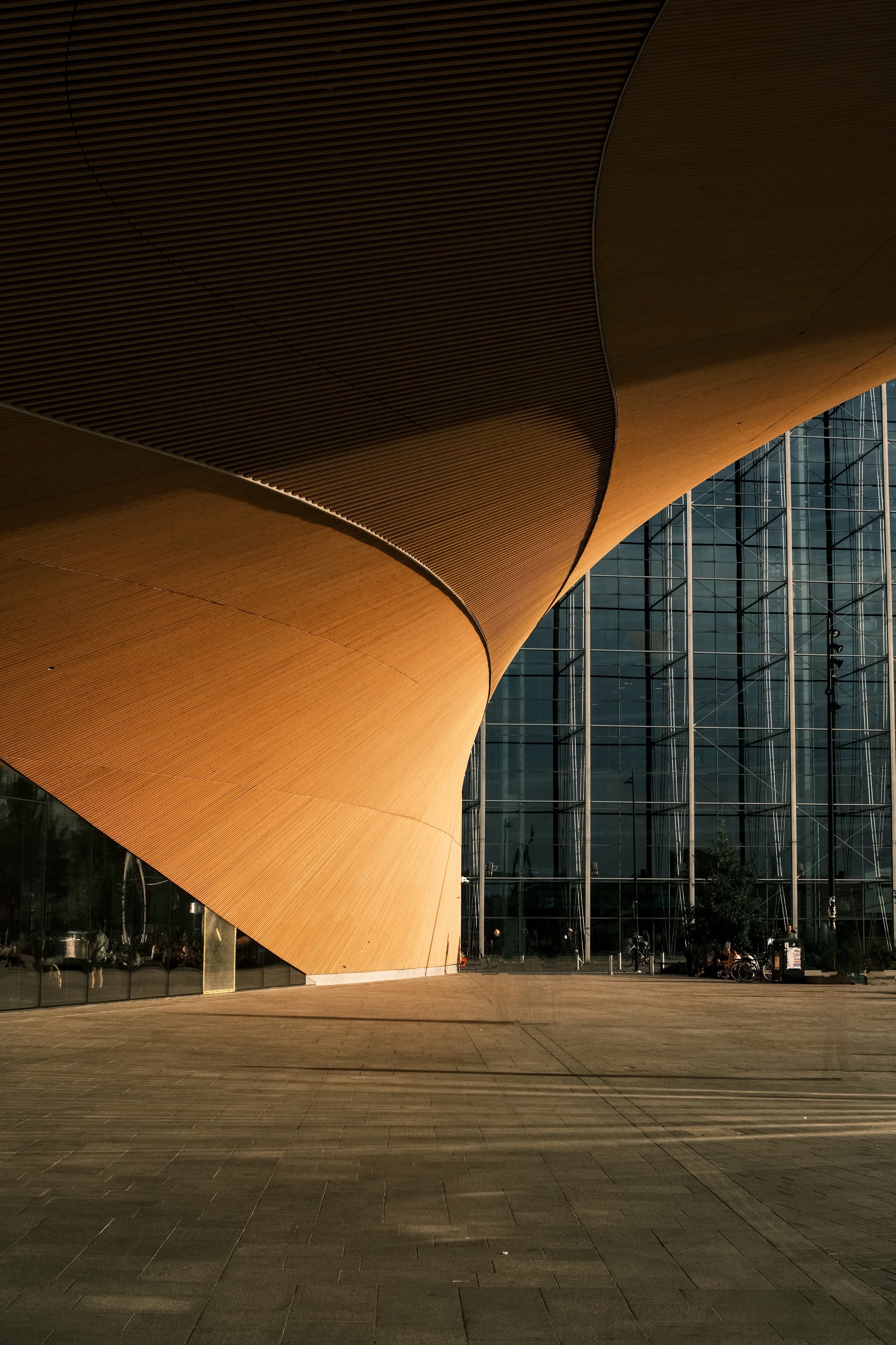 A building with a curved roof and a large curved wall · Free Stock Photo